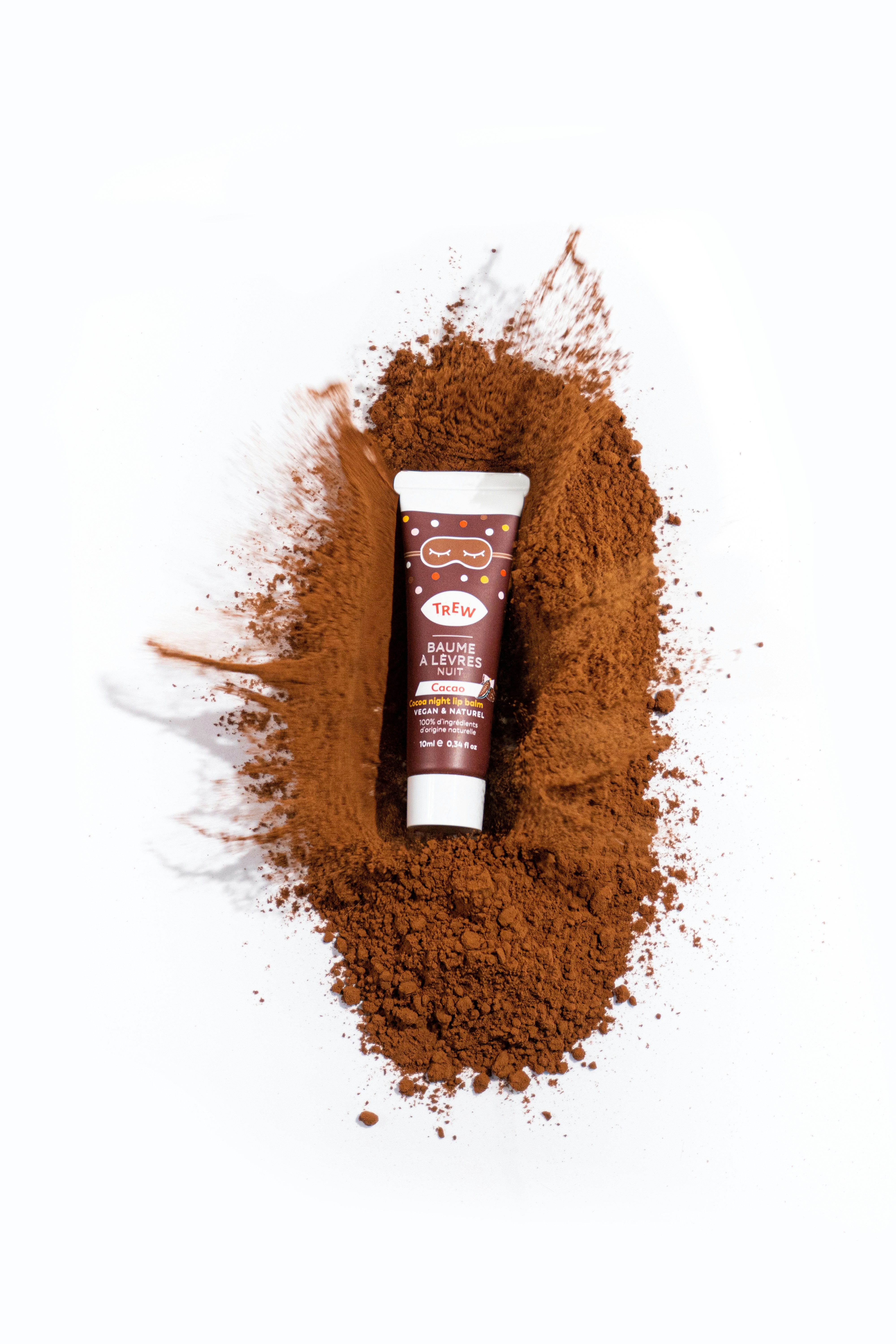 Cocoa Brown Lip Balm Emplaced in Ground Cocoa Scattering