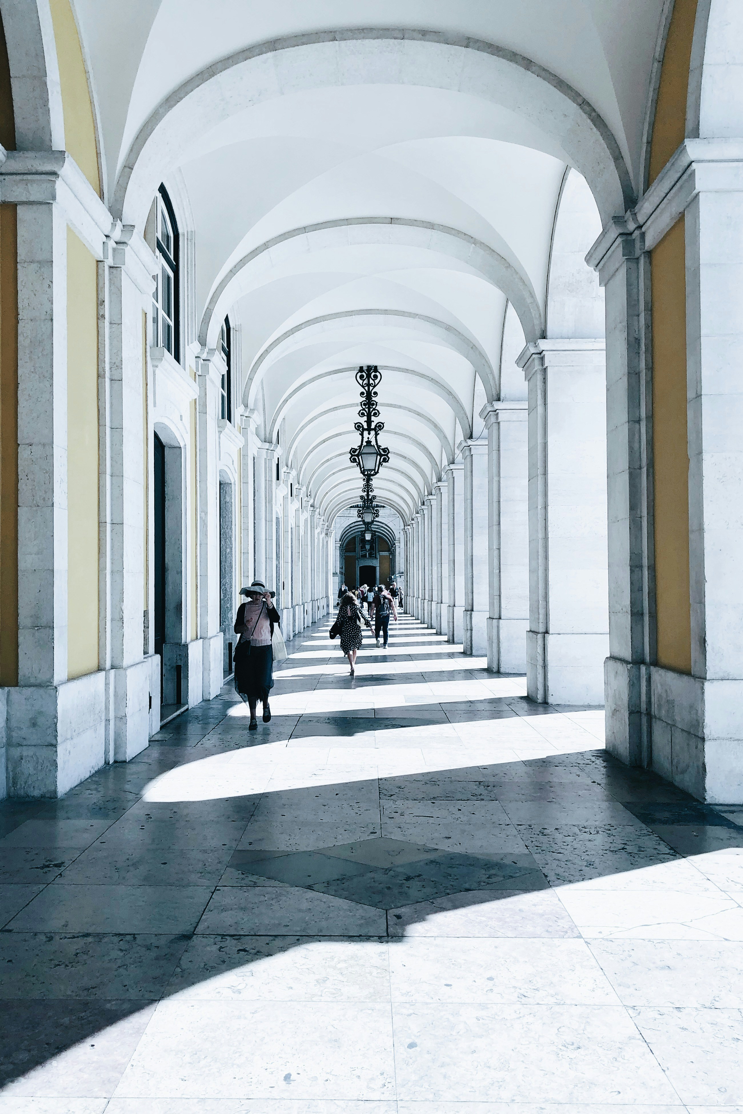 A group of people walking through a building photo – Free Architecture ...
