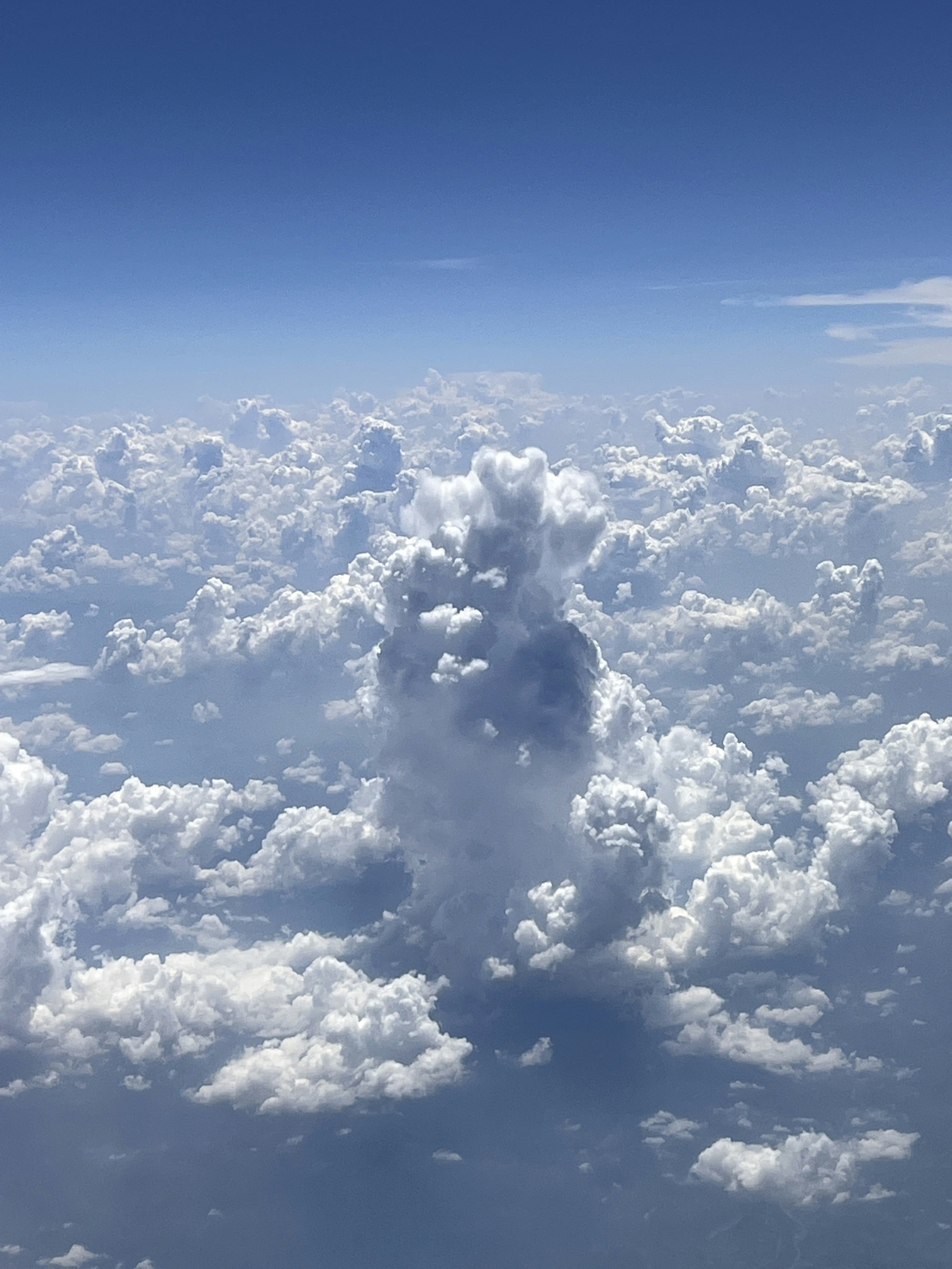 Cloudspire Rising: A Central Column Piercing a Sea of Blue