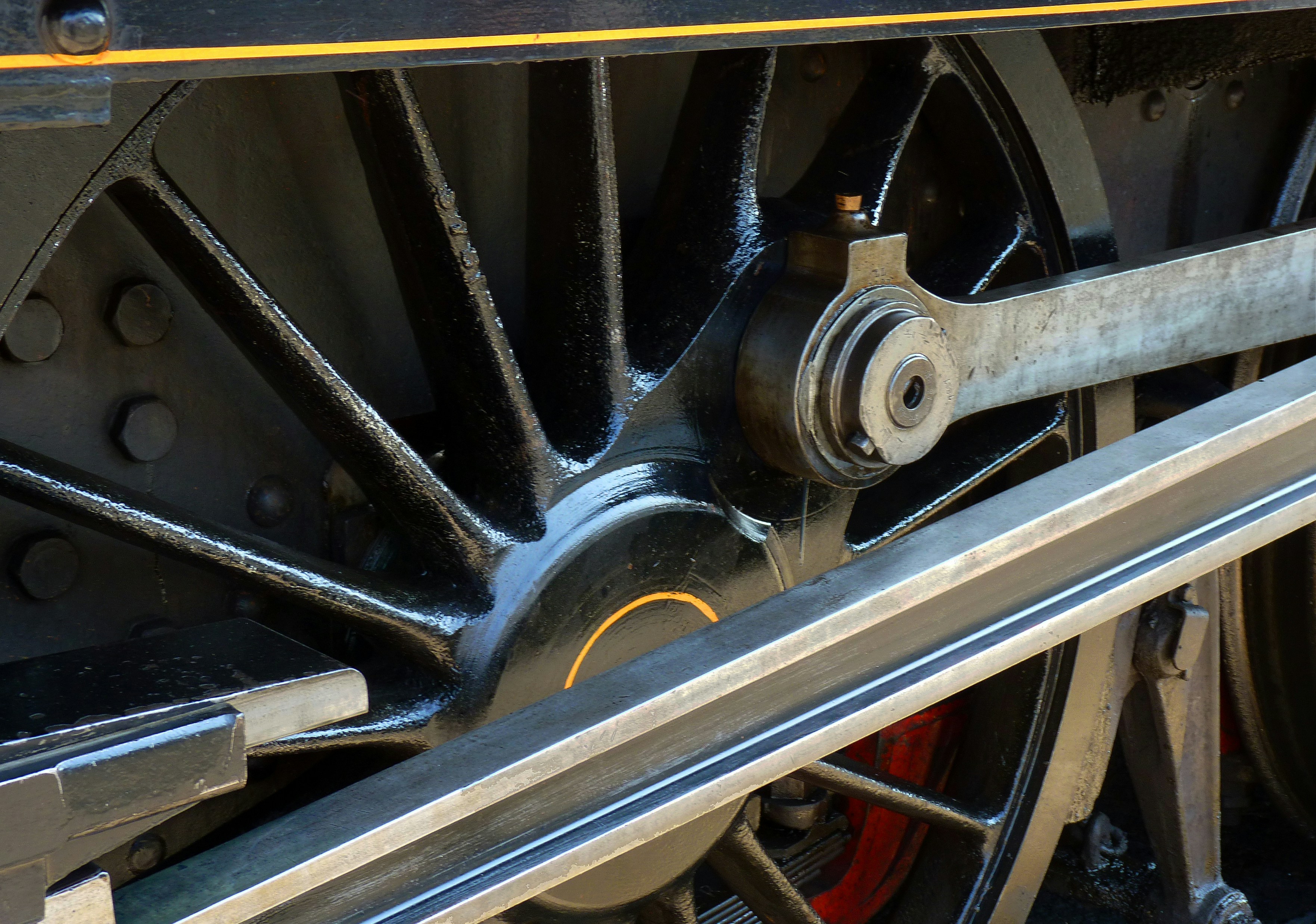 Iron Lattice in Motion: A Close-Up of a Steam Locomotive Wheel and Connecting Rod