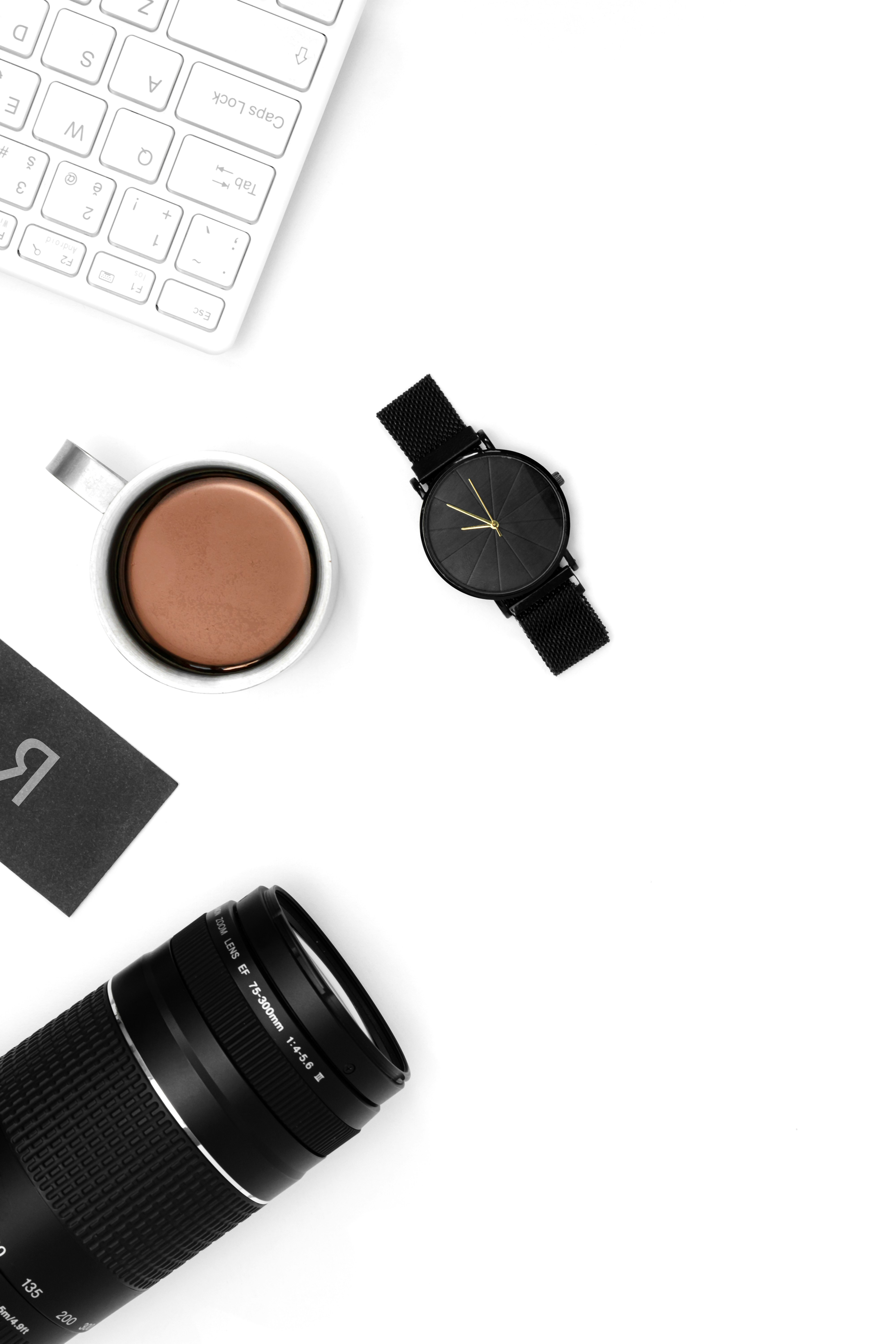 Time in Focus: A Minimal Flat-Lay of Watch, Coffee, and Lens
