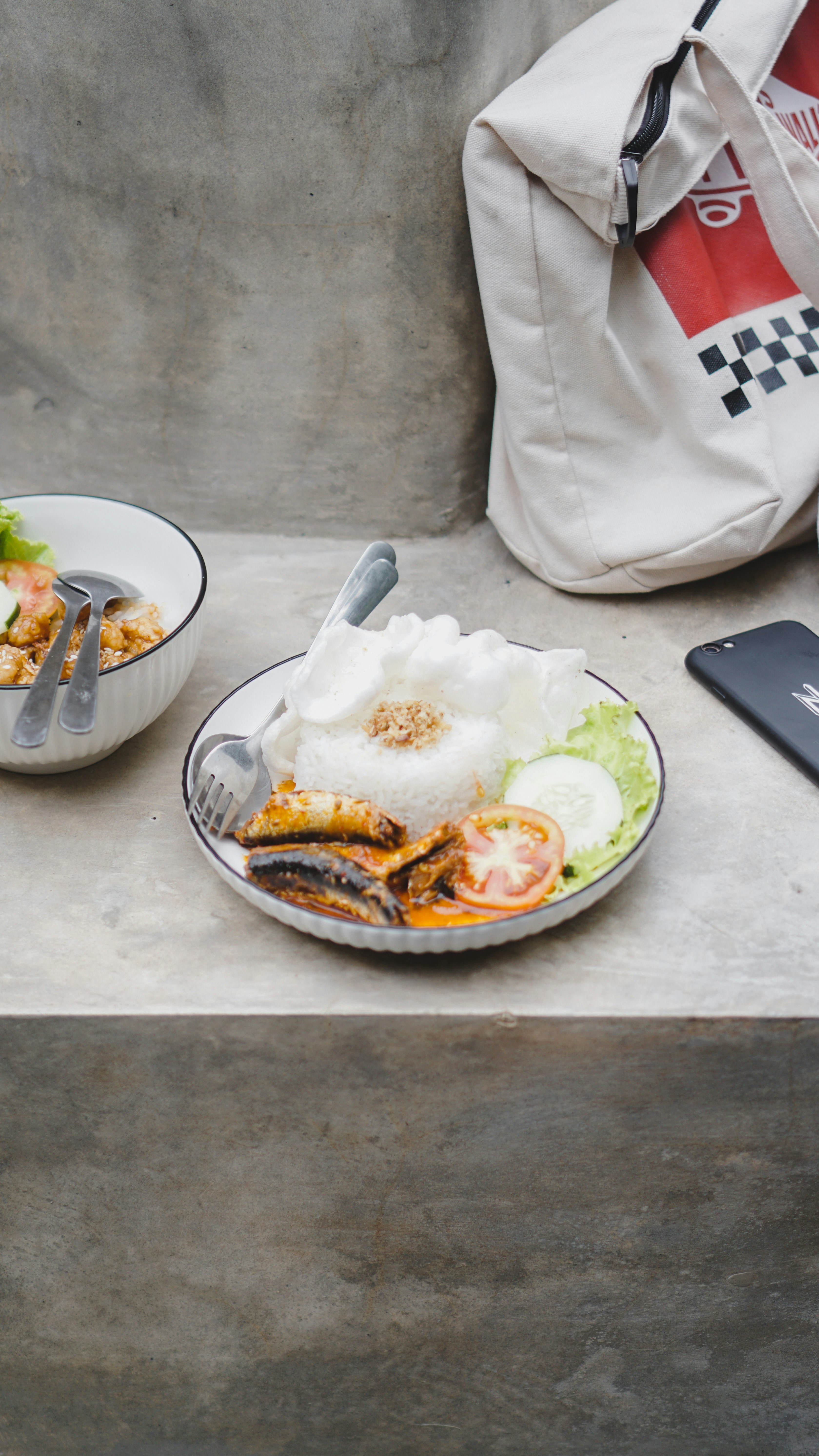 A Quiet Lunch Break: Rice, Sauce, and Greens on Concrete