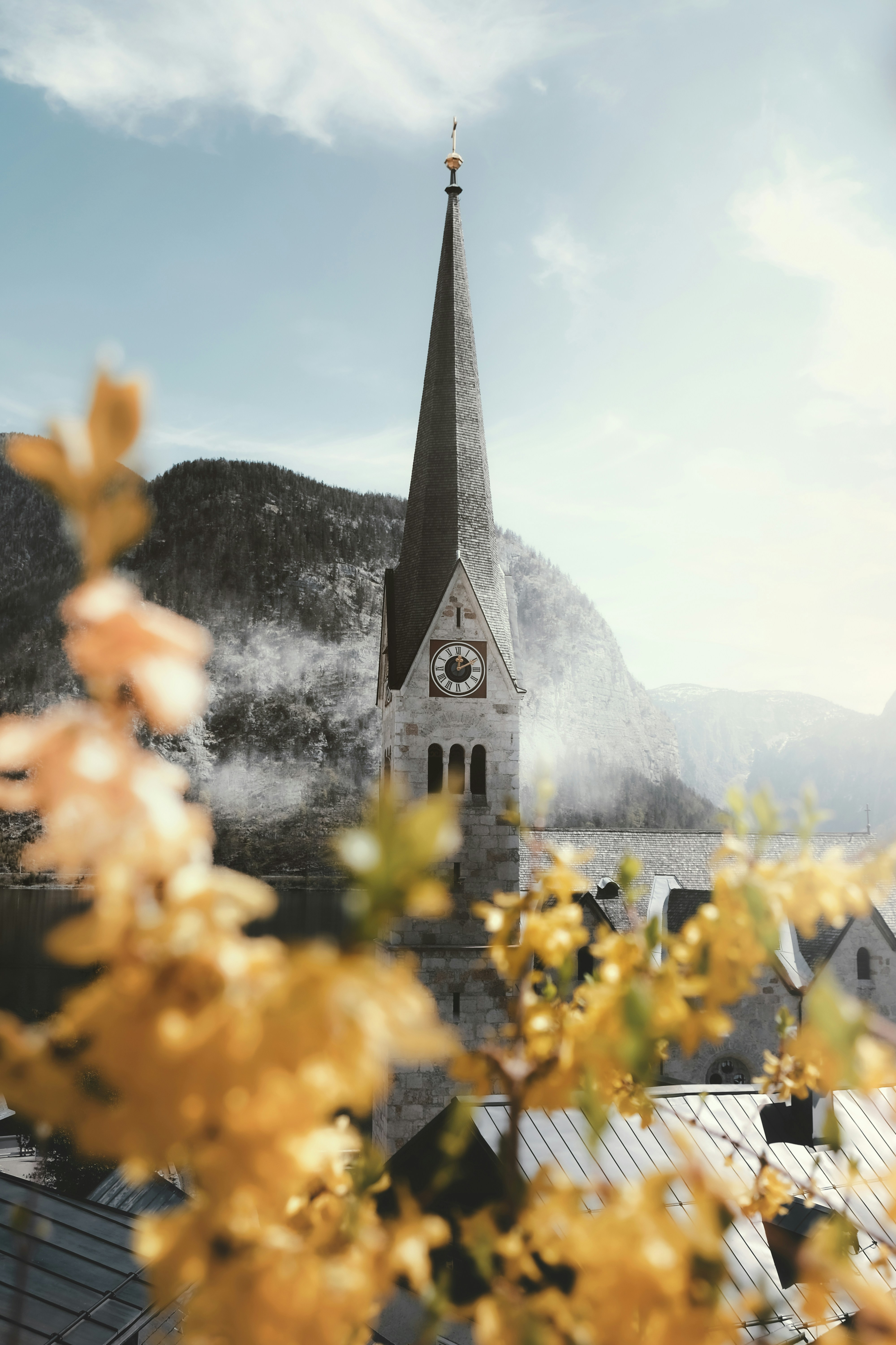 Alpine Steeple Emerges Through Golden Autumn Foliage