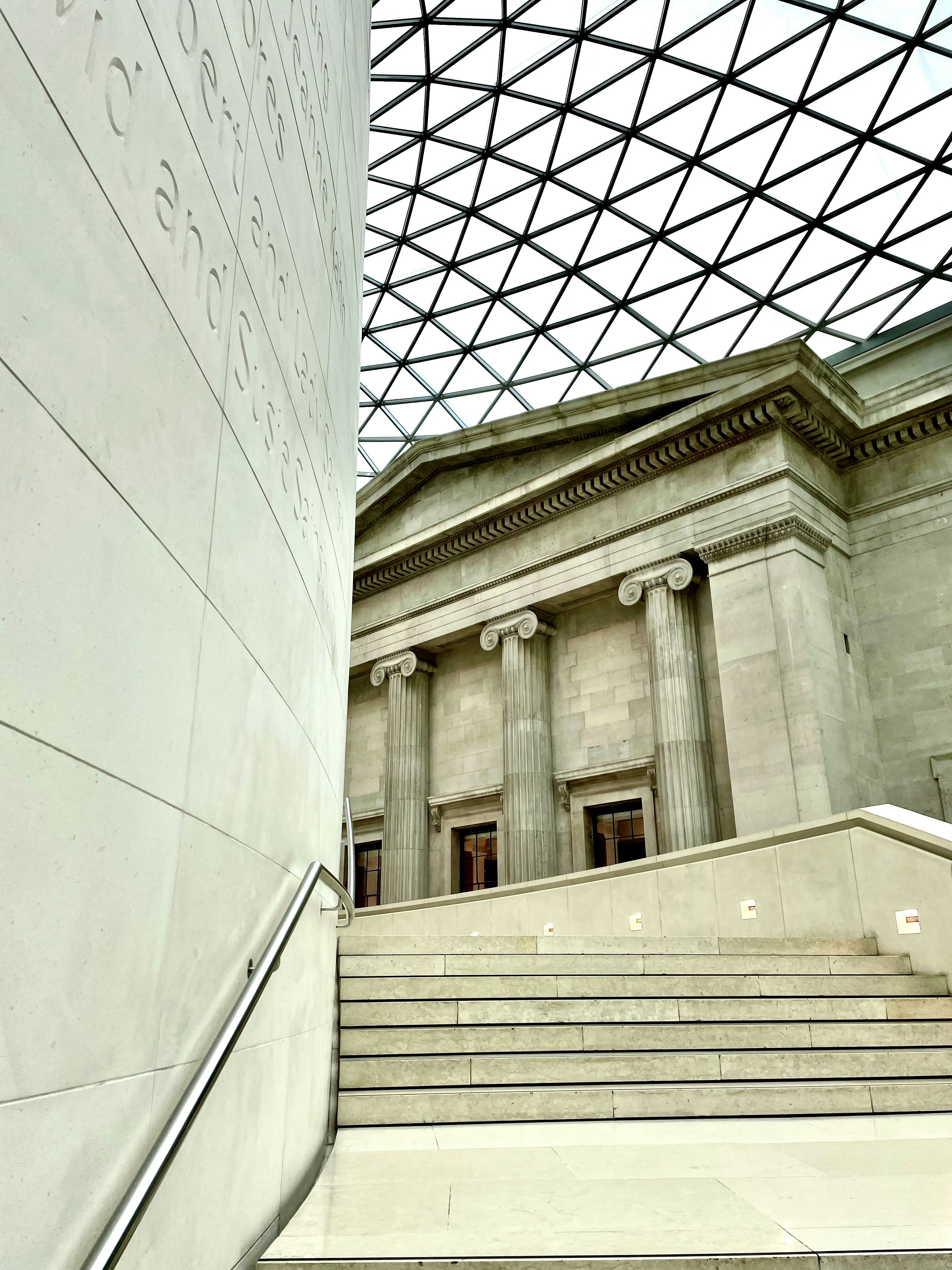 Geometry in Stone: Staircase and Columns Under the Glass Atrium