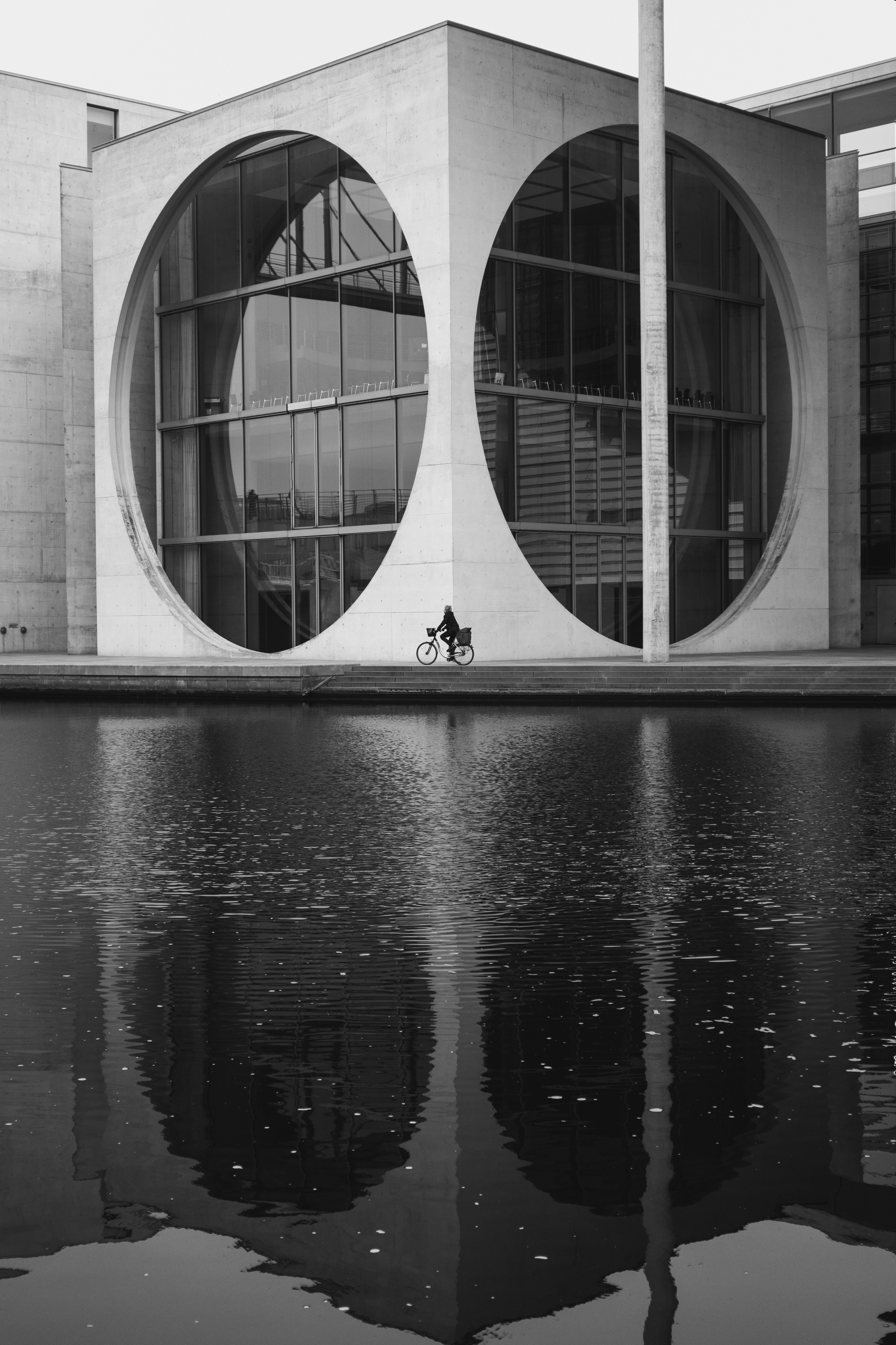 Cyclist in the Ring: A Quiet Moment by the Circular Facade