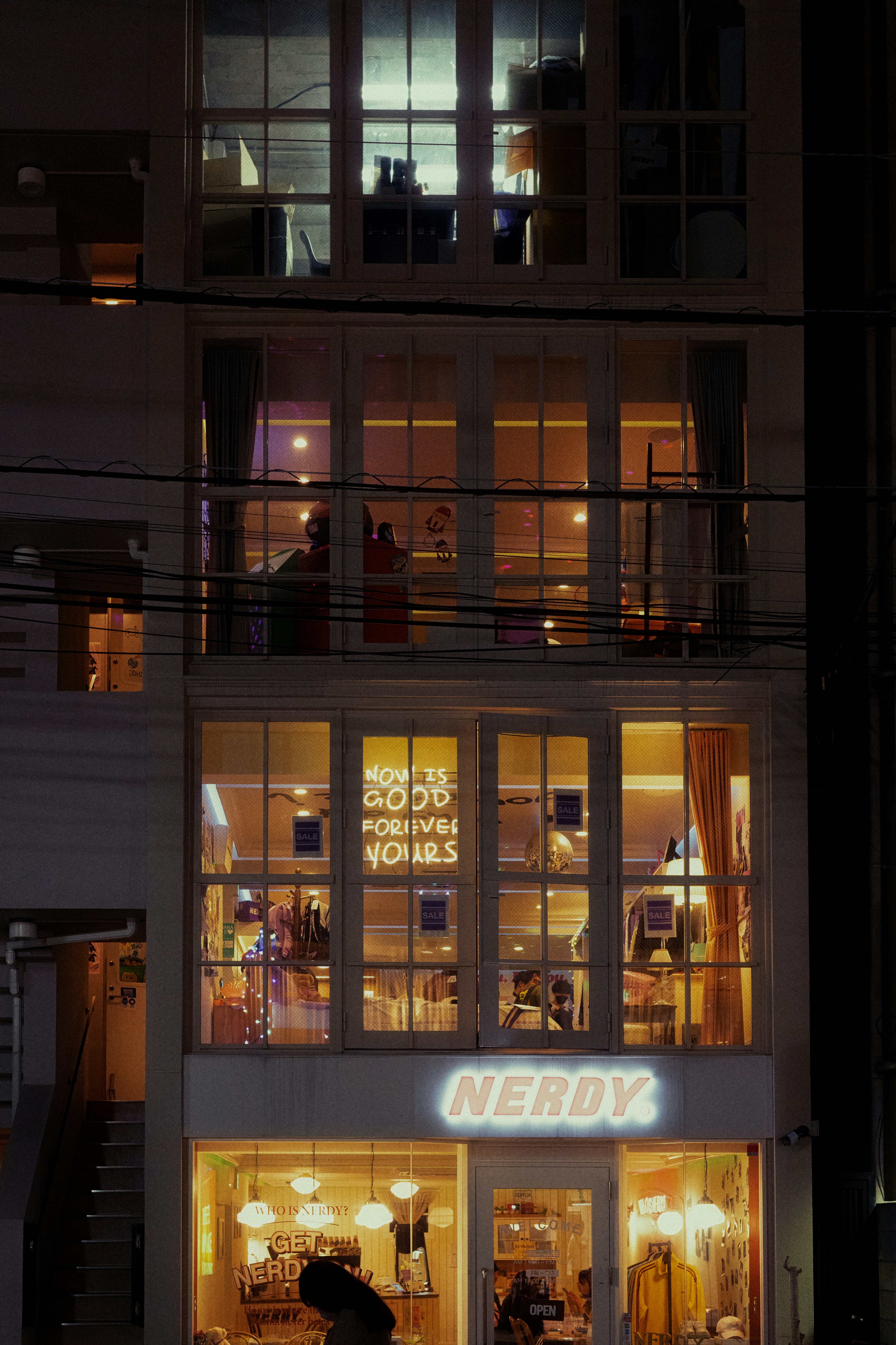 Nerdy Glow: The Neon Storefront Bursts Through Night Window Lights