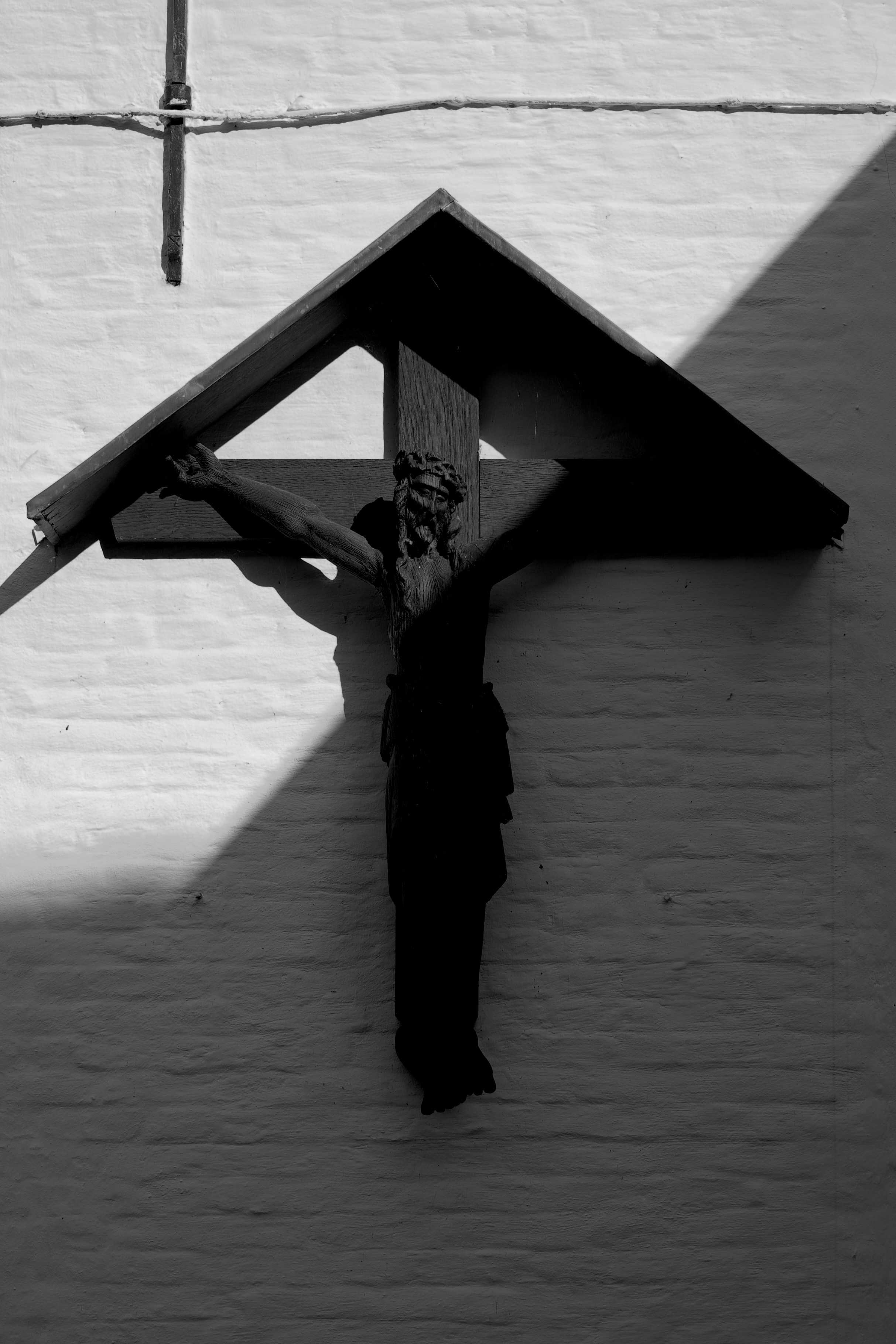 a statue of a person holding a cross