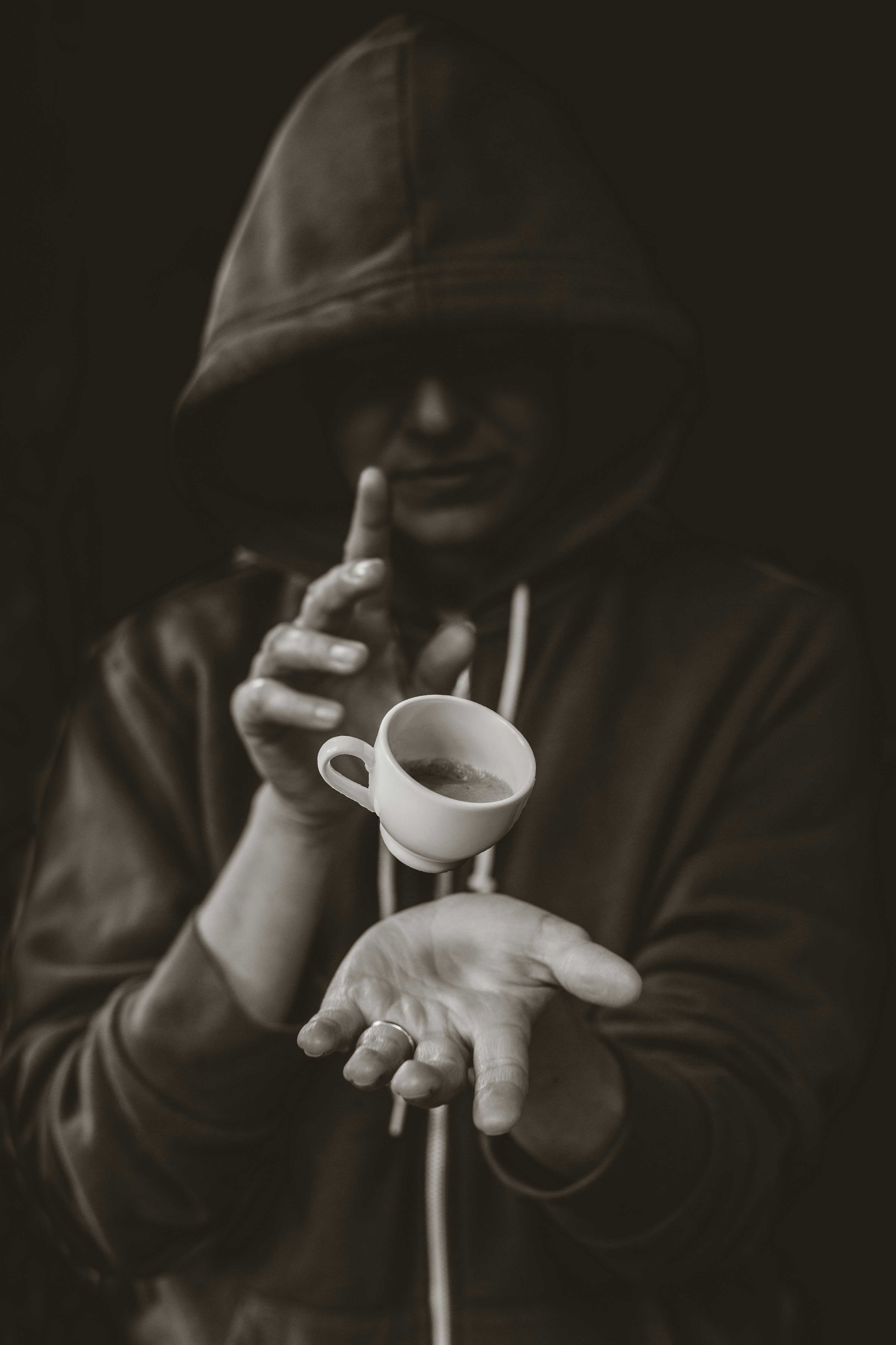 A Quiet Offering: The Tiny Cup Cast in Shadowed Hands
