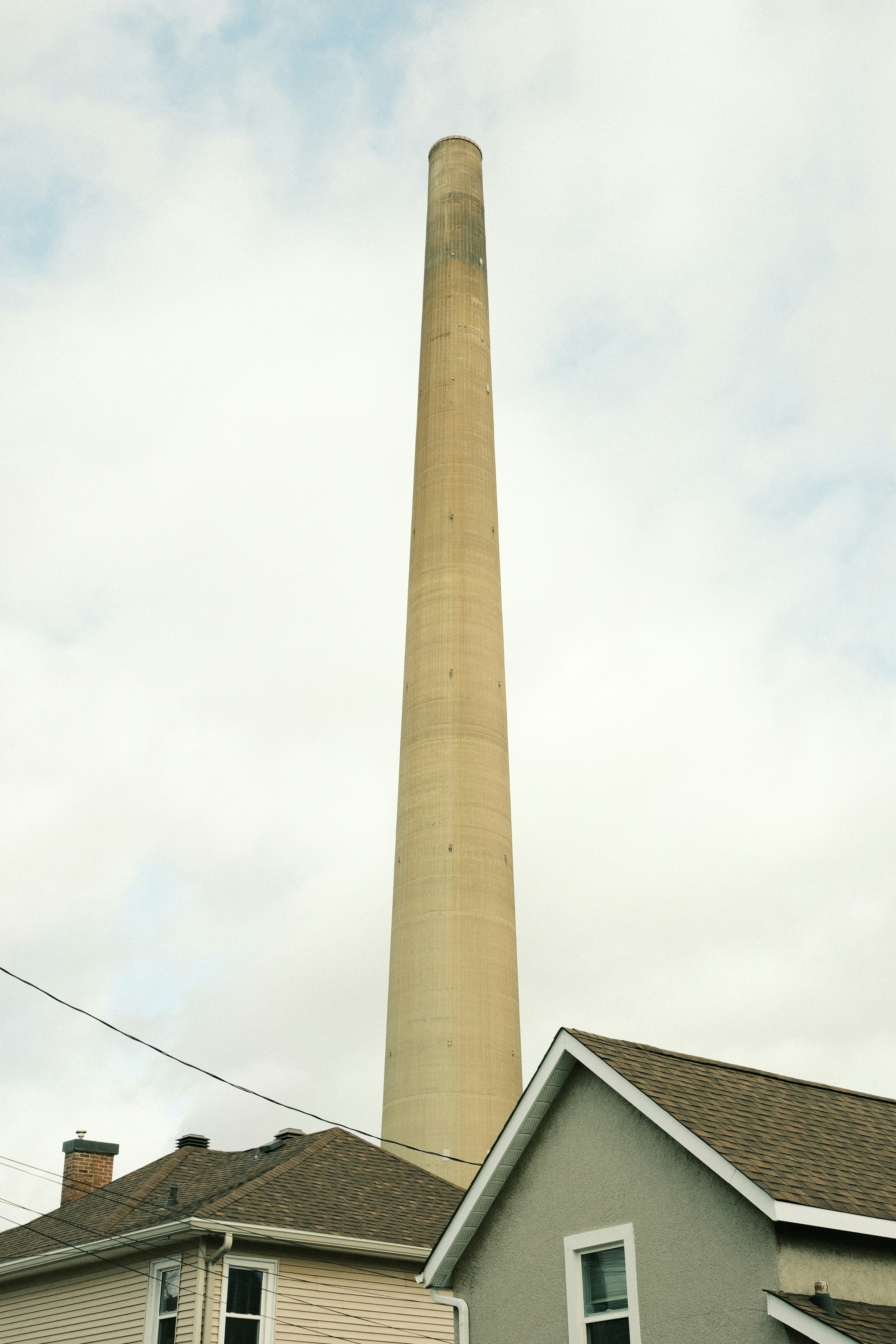 Chimney Rising: A Quiet Sky Above Rooftops