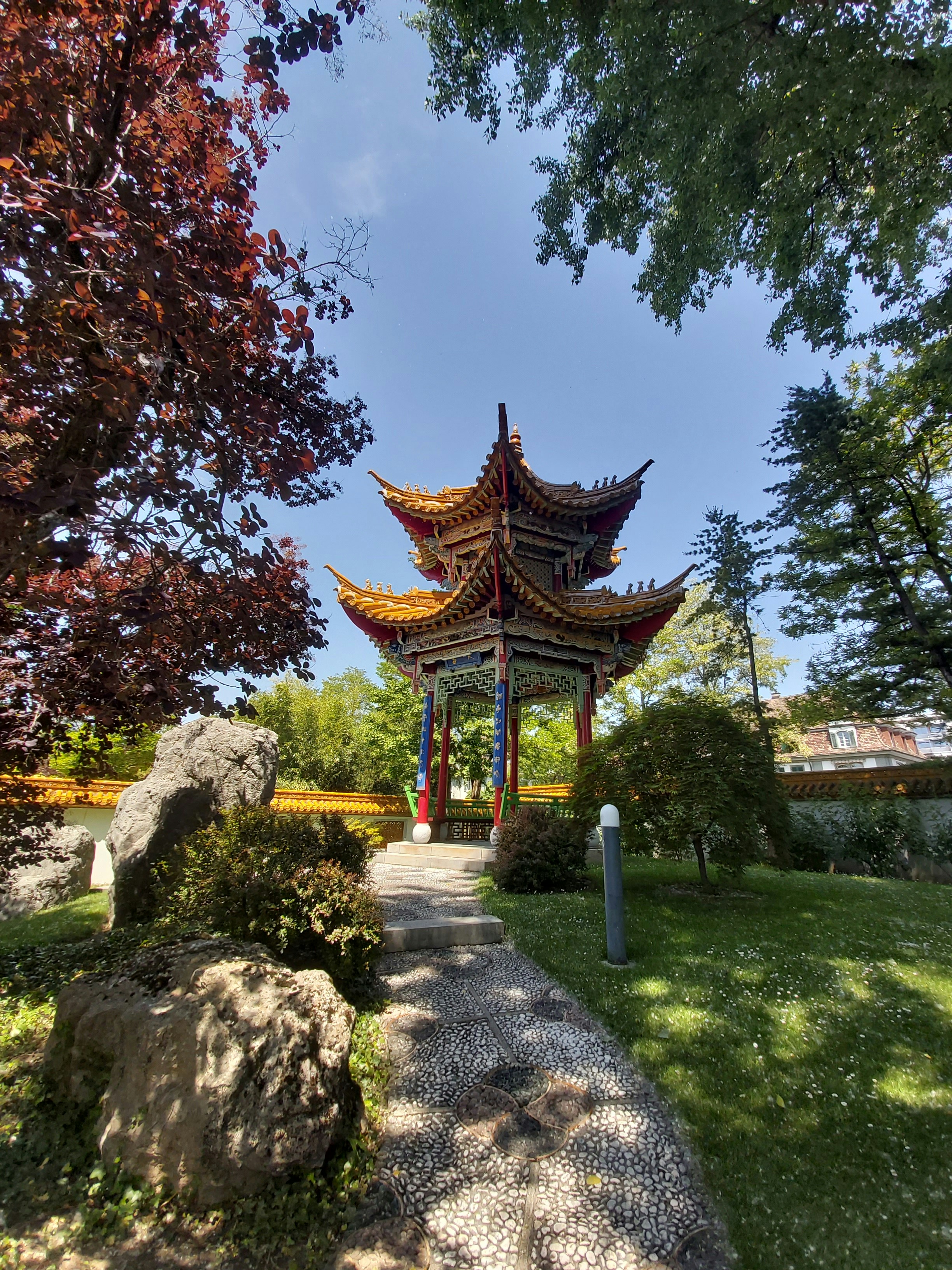 Sunlit Chinese Pagoda Framed by a Tranquil Garden Path