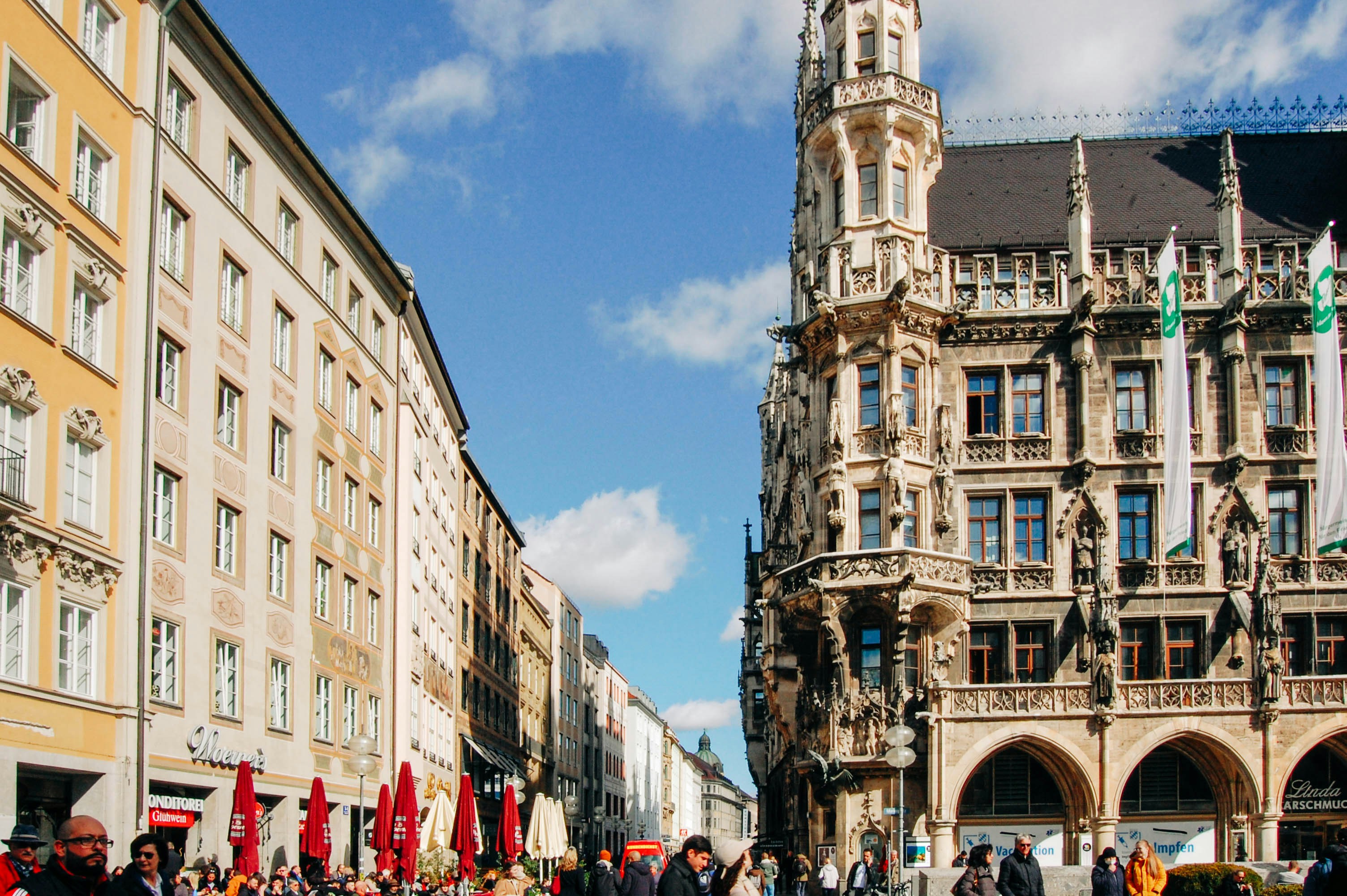 A group of buildings with people walking around photo – Free Blue Image ...