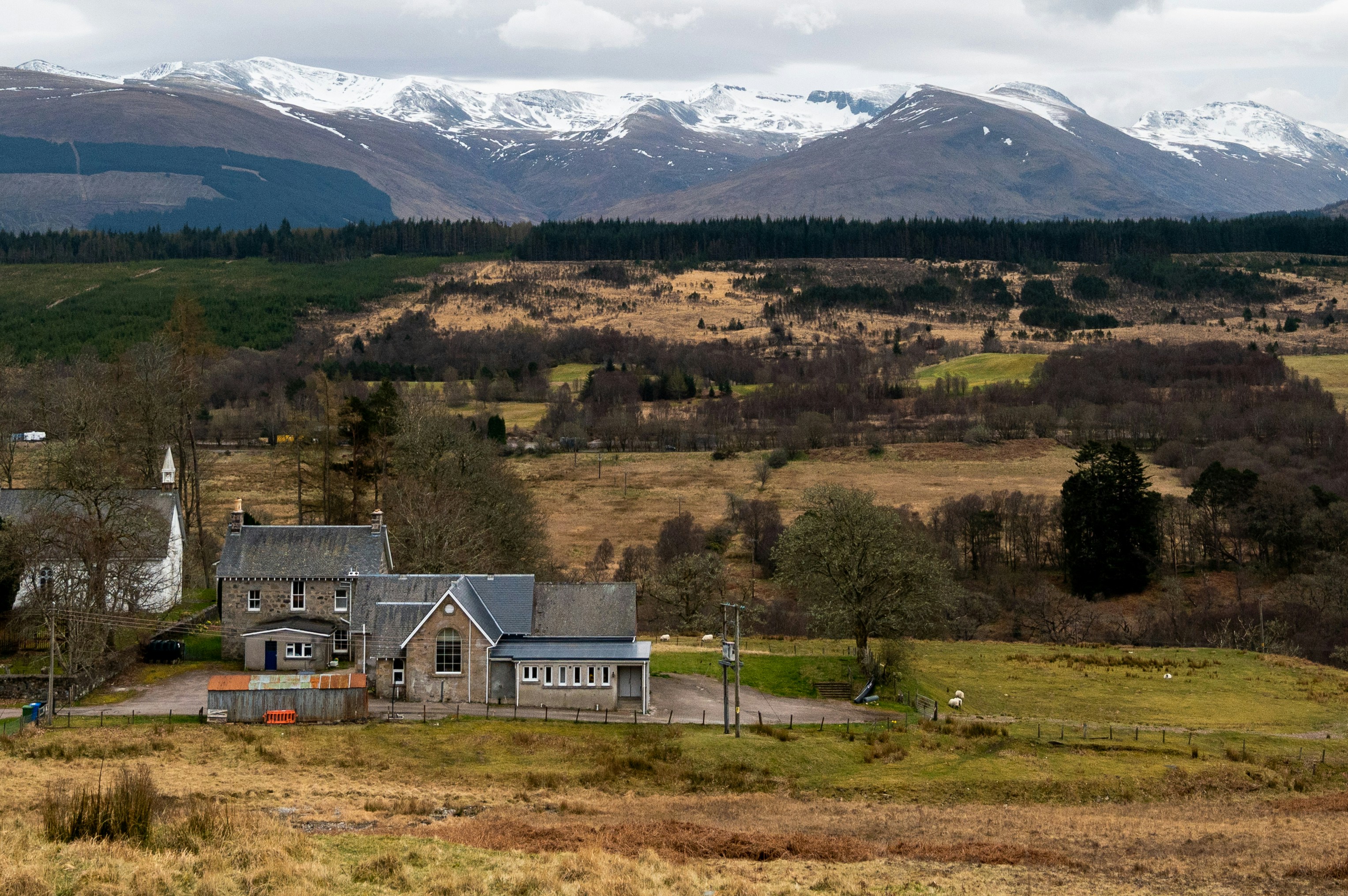 Stone Church at the Moor's Edge Beneath Snow-Capped Peaks