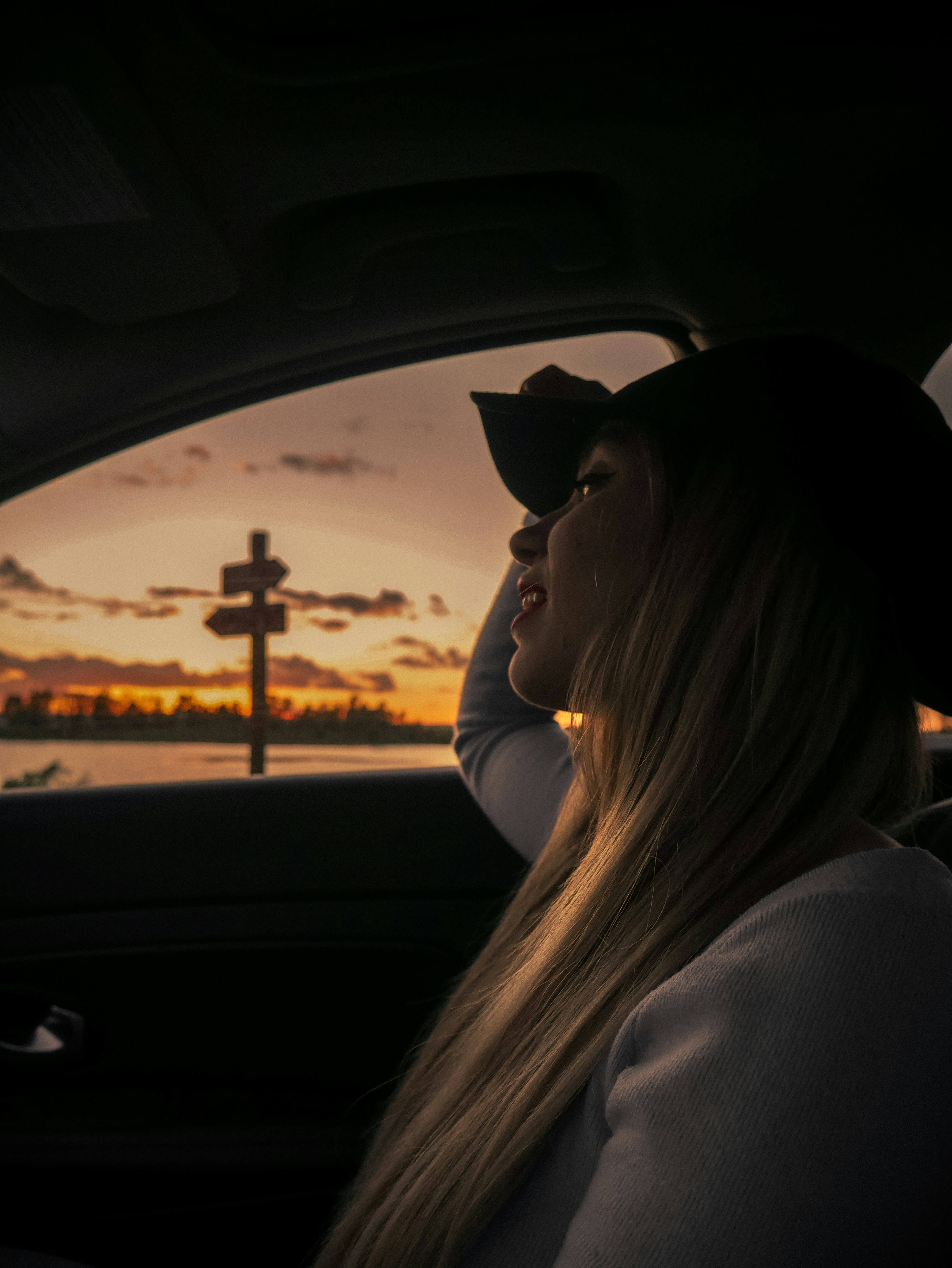 Sunset Drive: Silhouette of a Woman in Profile Inside a Car