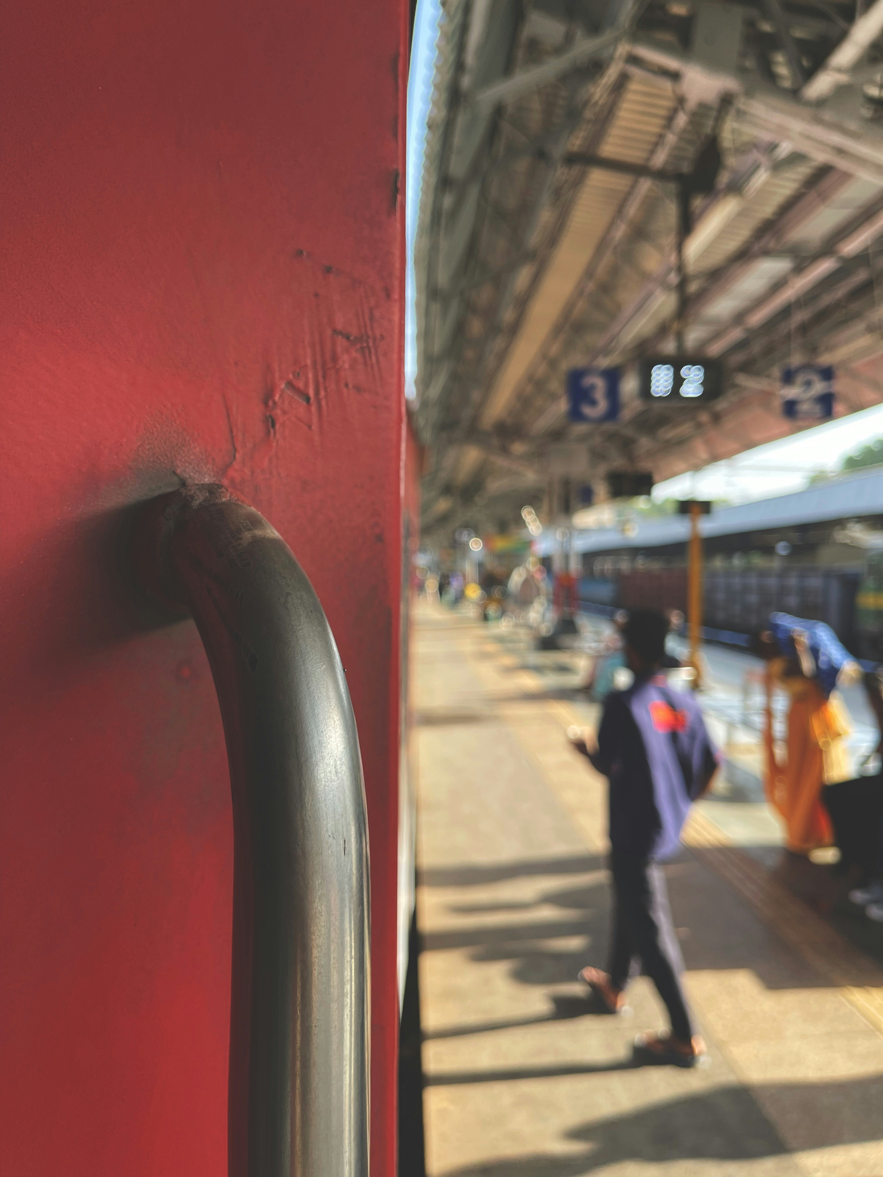 Red Steel Edge: Close-Up Framing a Platform Handrail