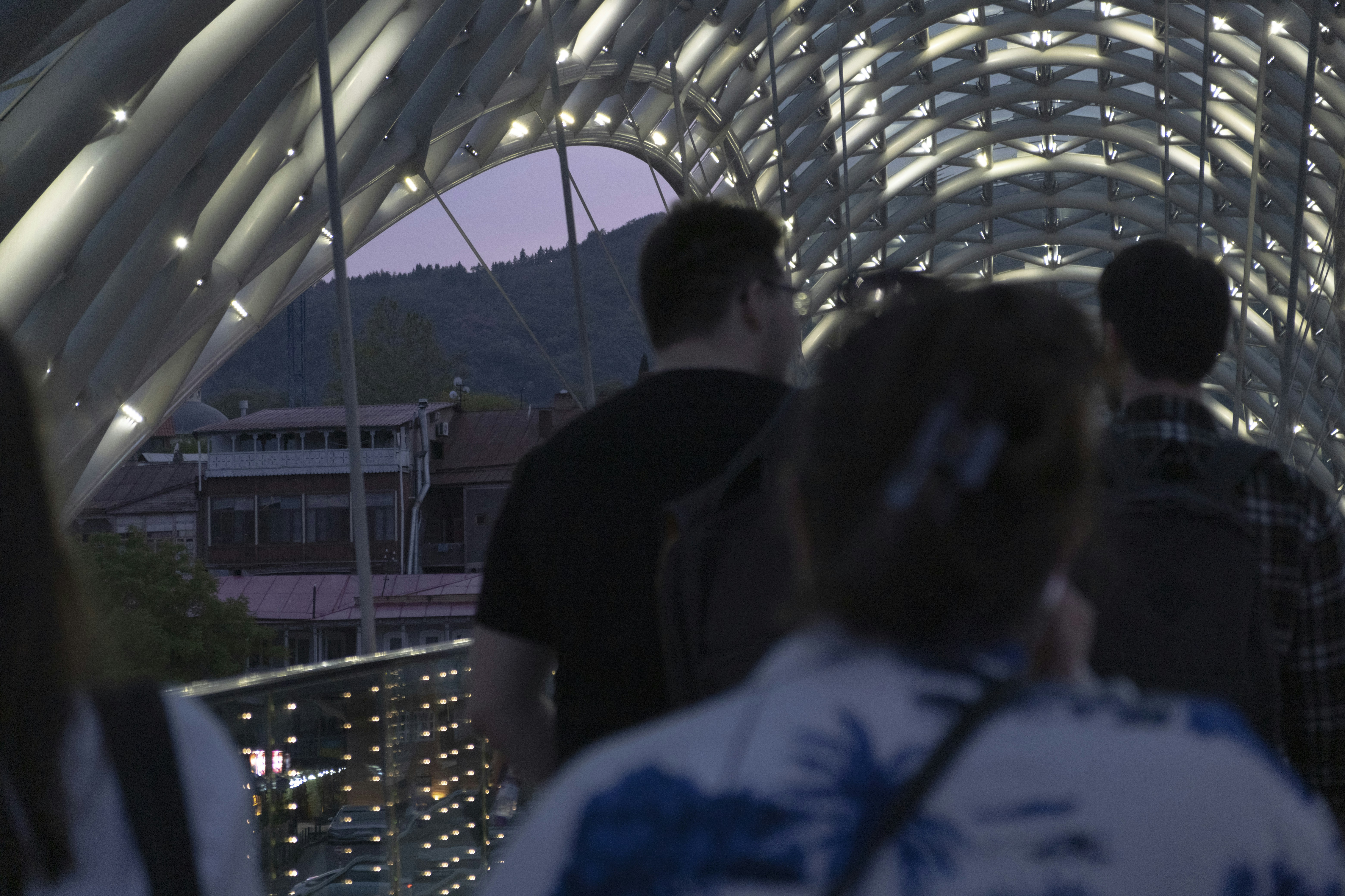 Glow under the Arc: Evening Walk Across a Lumined Bridge