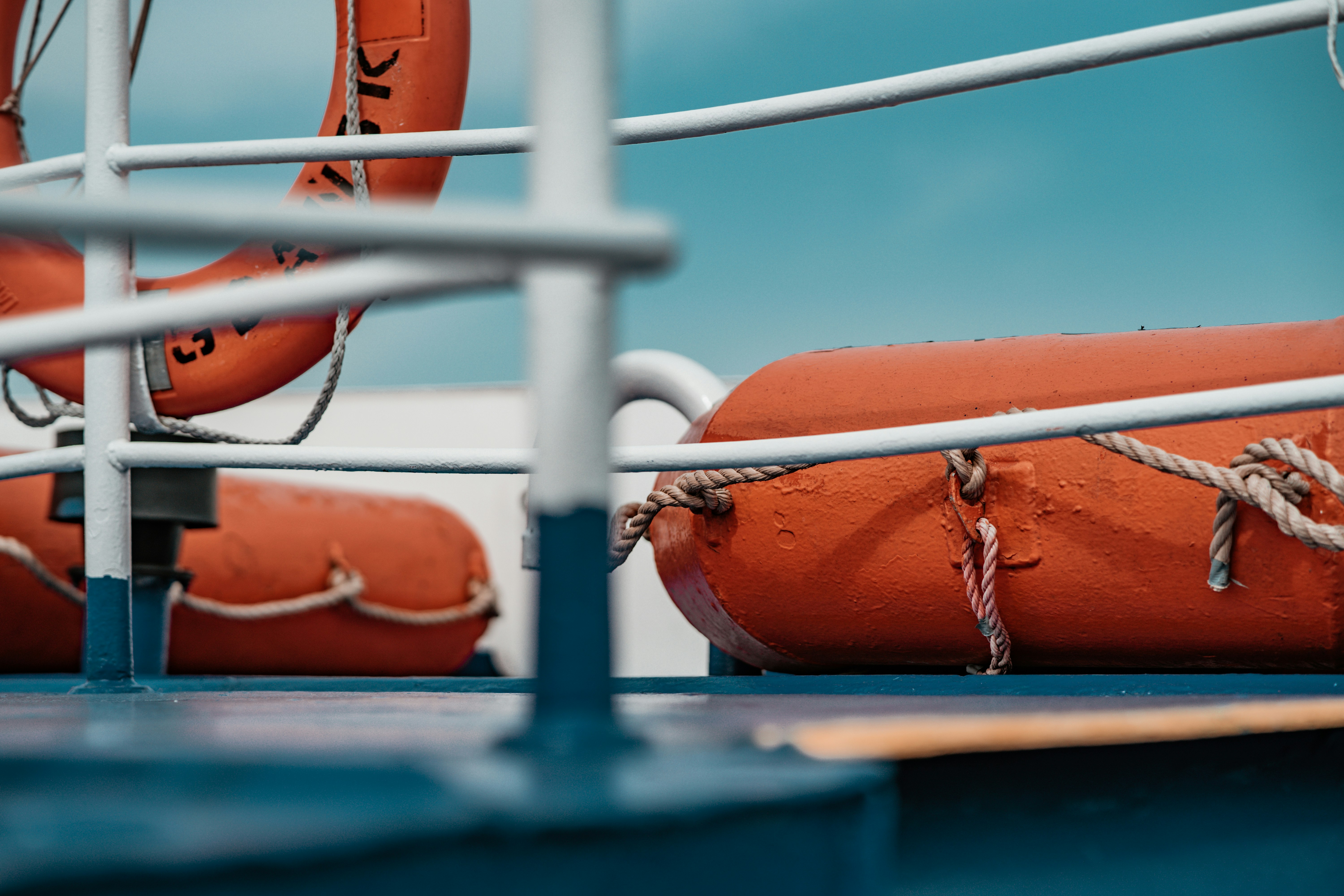 A group of orange and white buoys on a metal pole photo – Free Gdynia ...