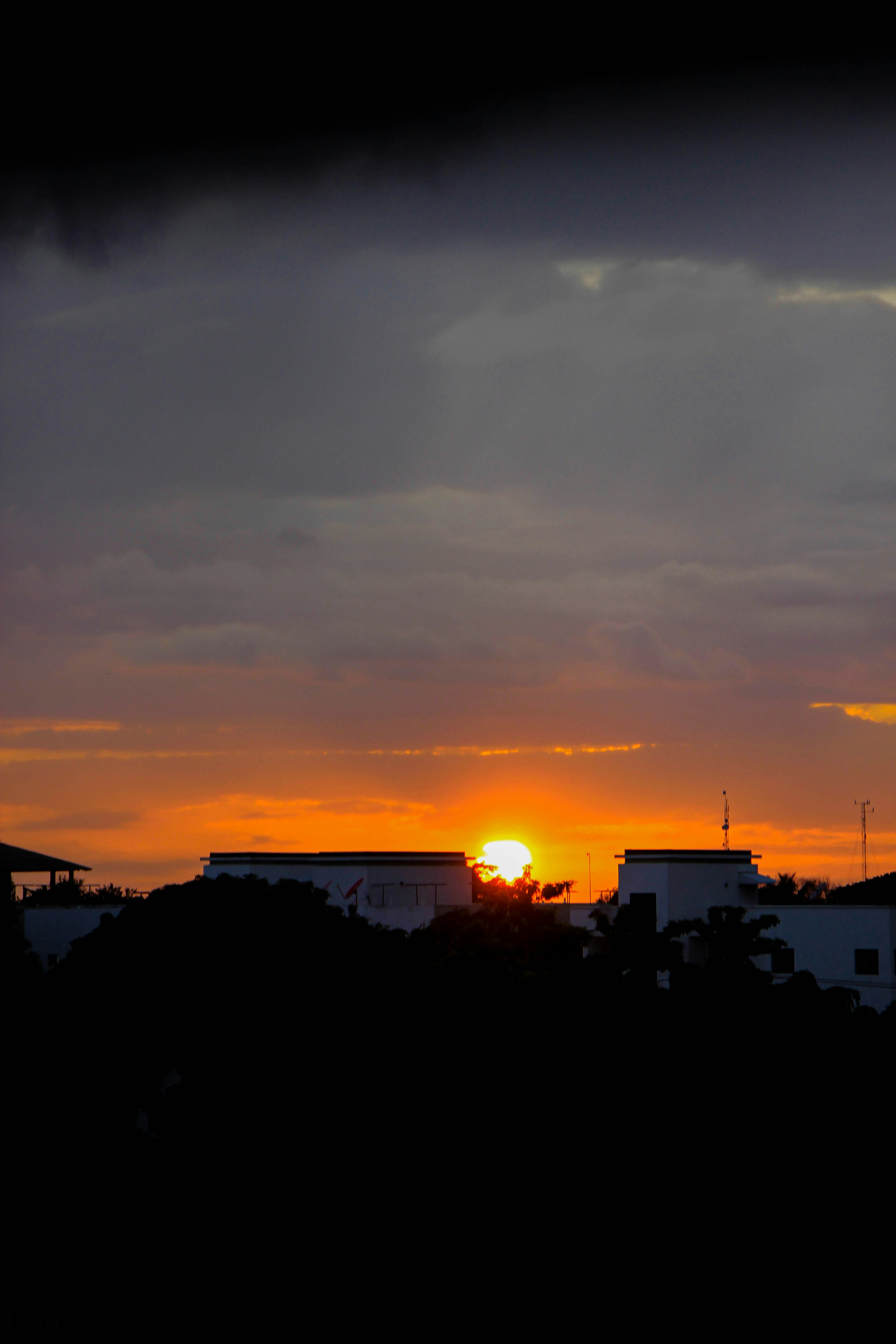 Horizon Ember: Sunset Against a Shadowed Cityscape