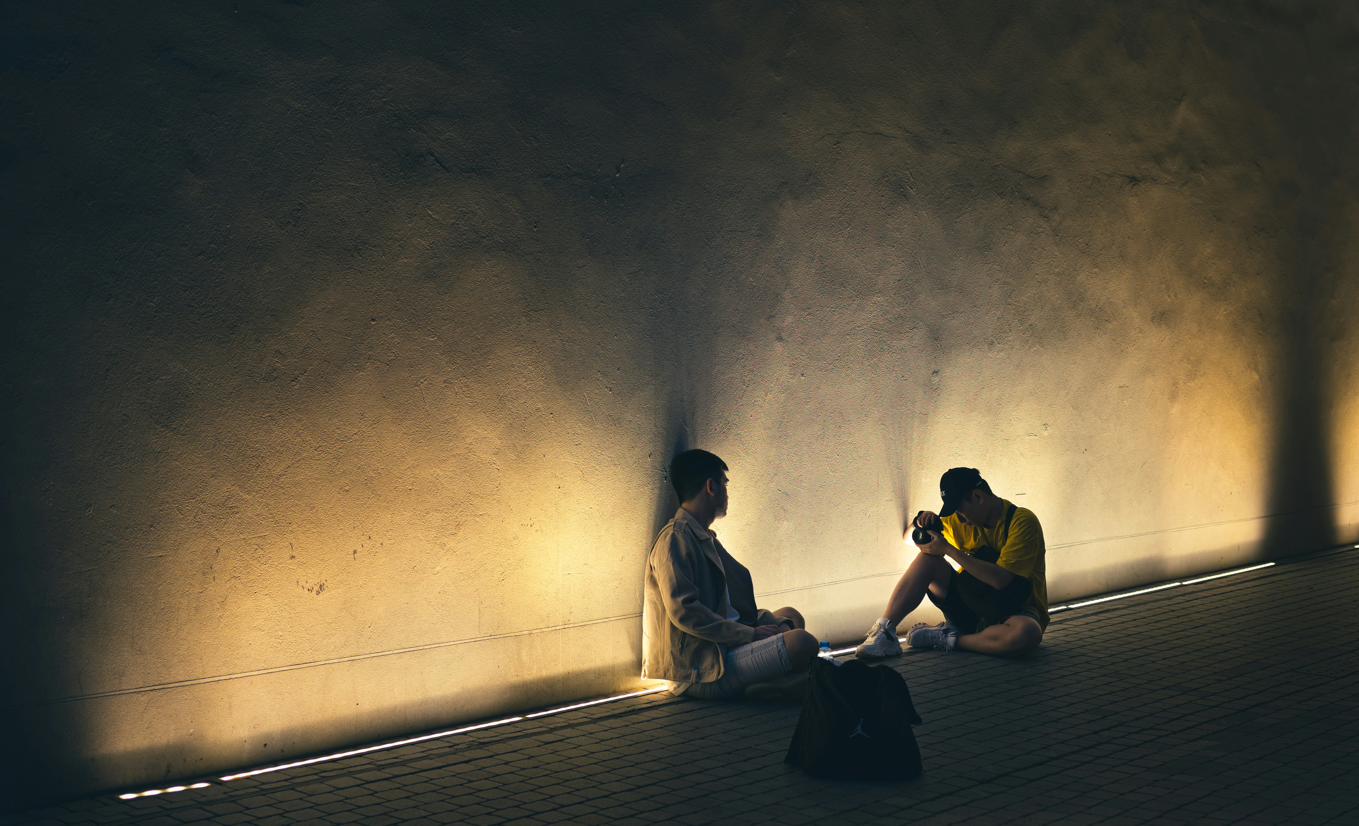 Quiet Corner: Two Friends in a Backlit Tunnel