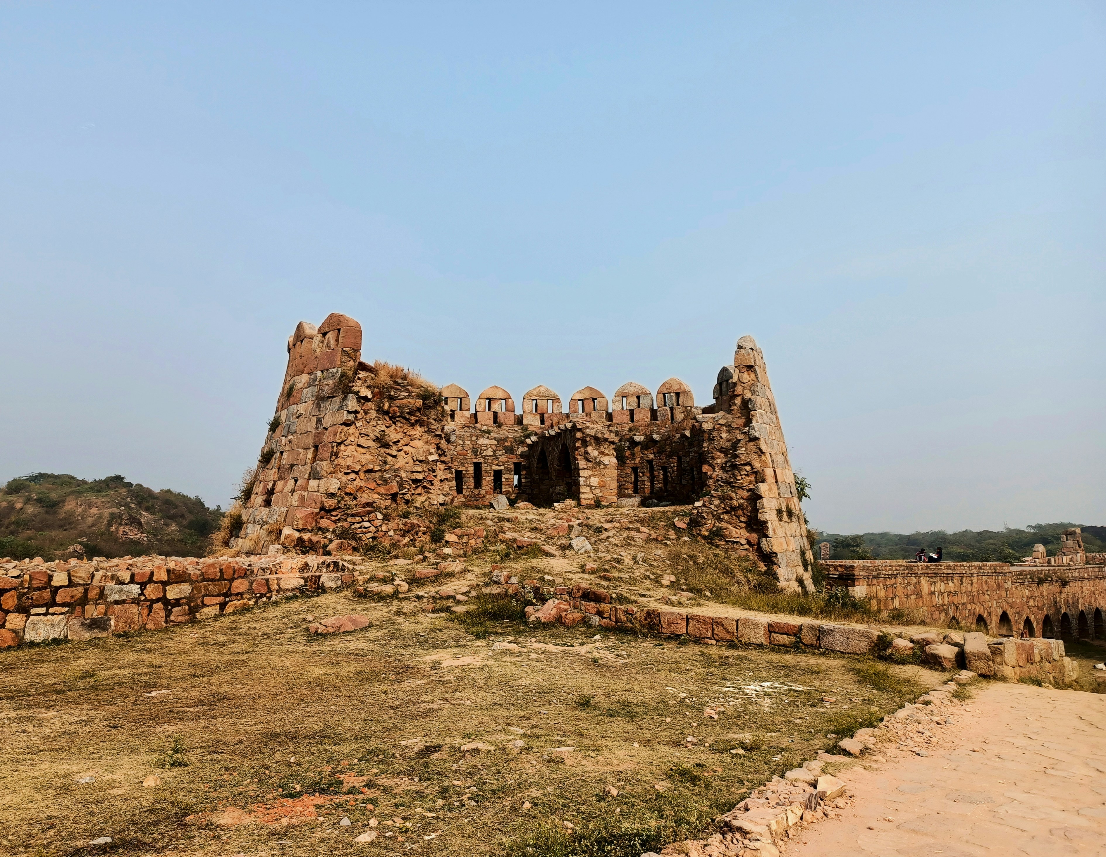 A stone building with a stone wall photo – Free Tughlaqabad fort Image ...