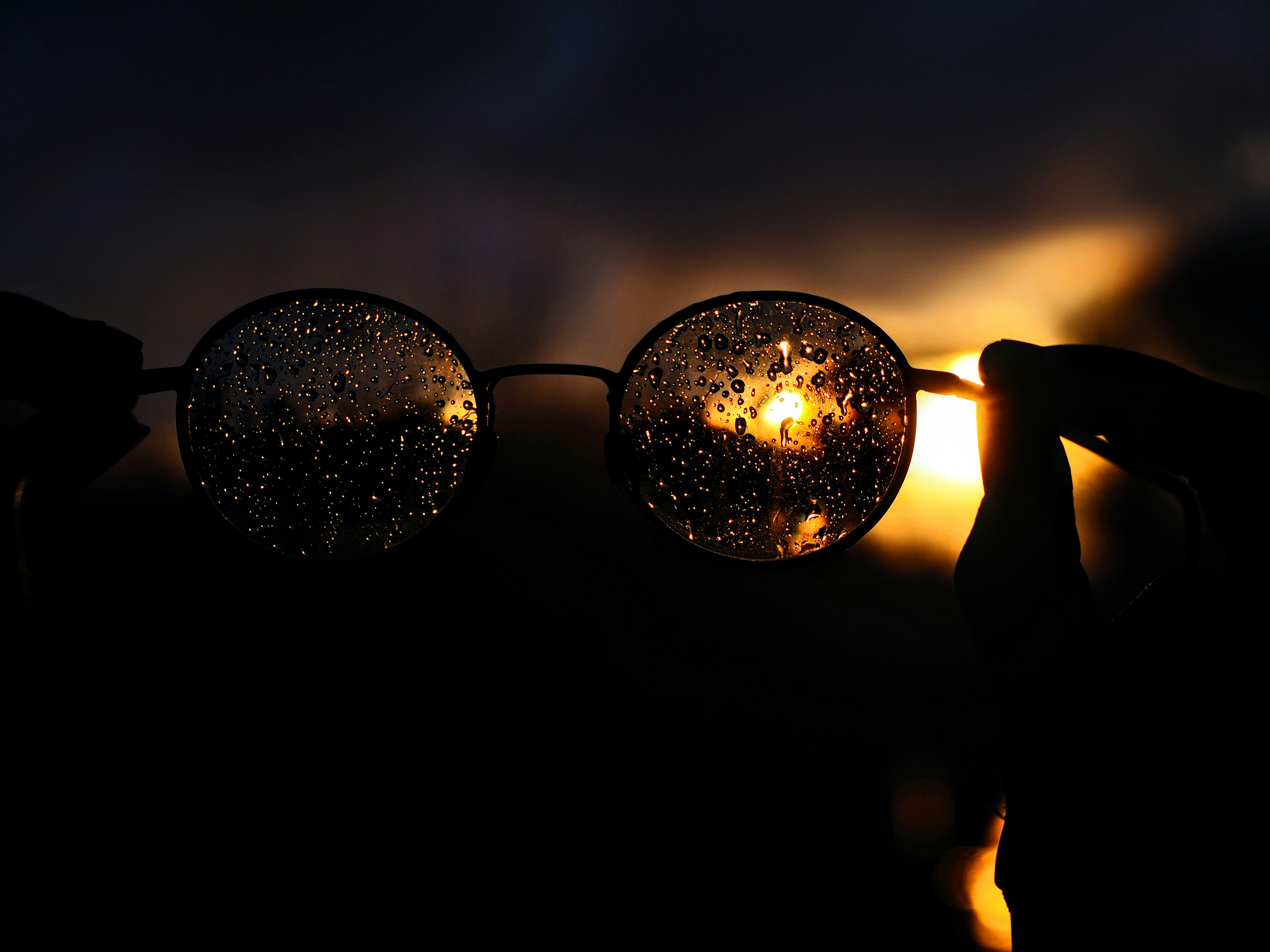 Glowing Orbs: Light Beads on Rainy Lens Between the Frames