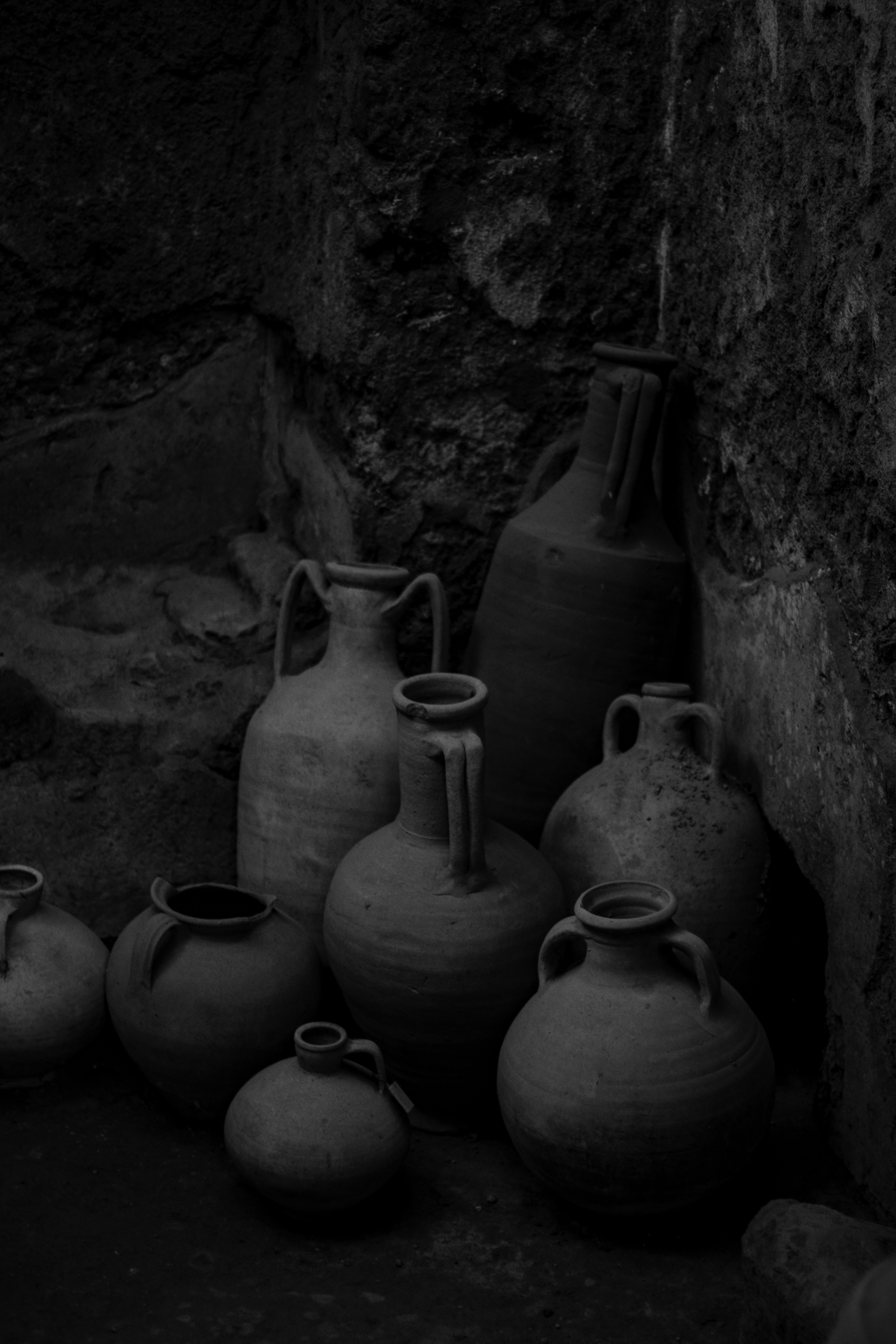 a group of vases sit in a room