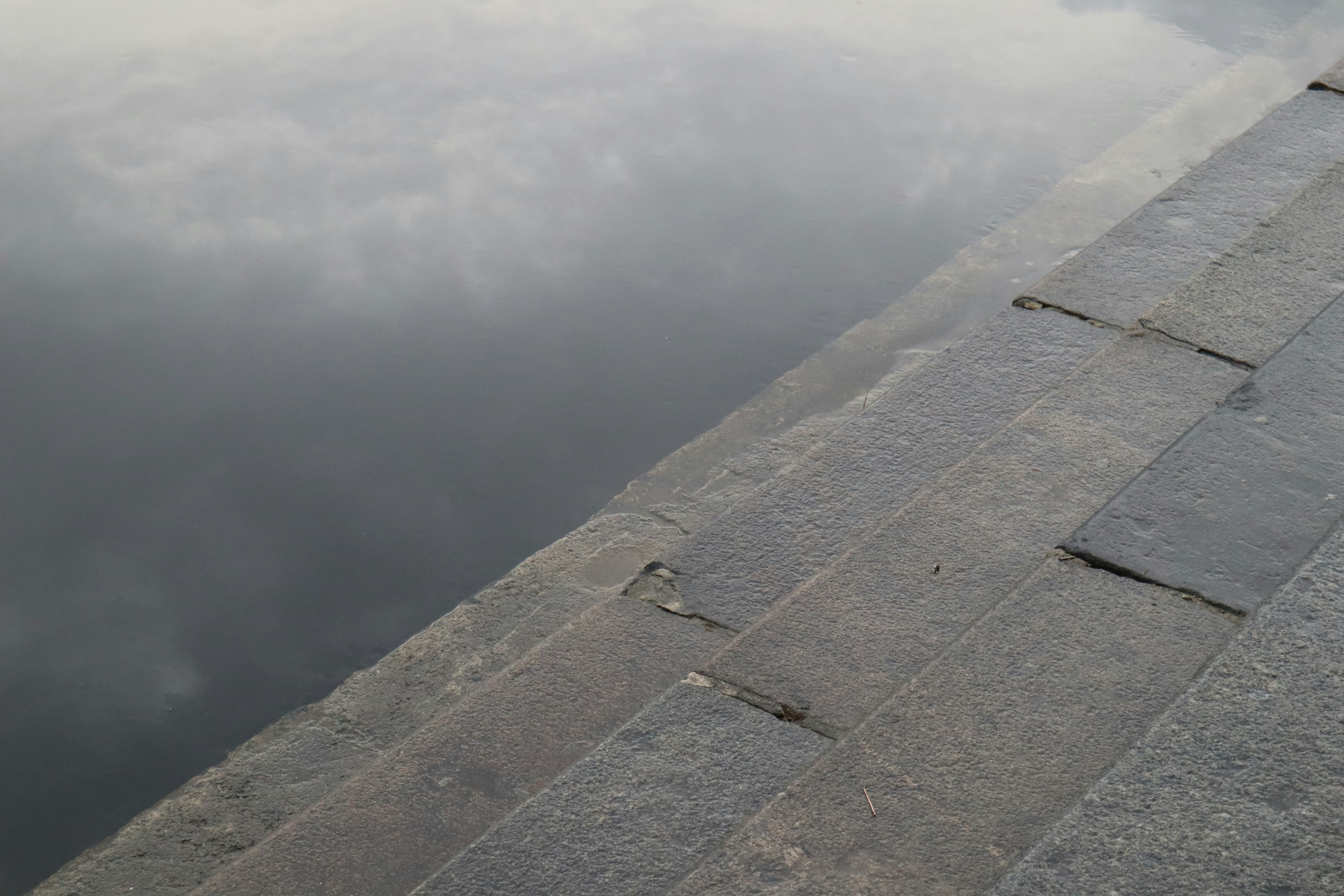a stone walkway with a stone wall