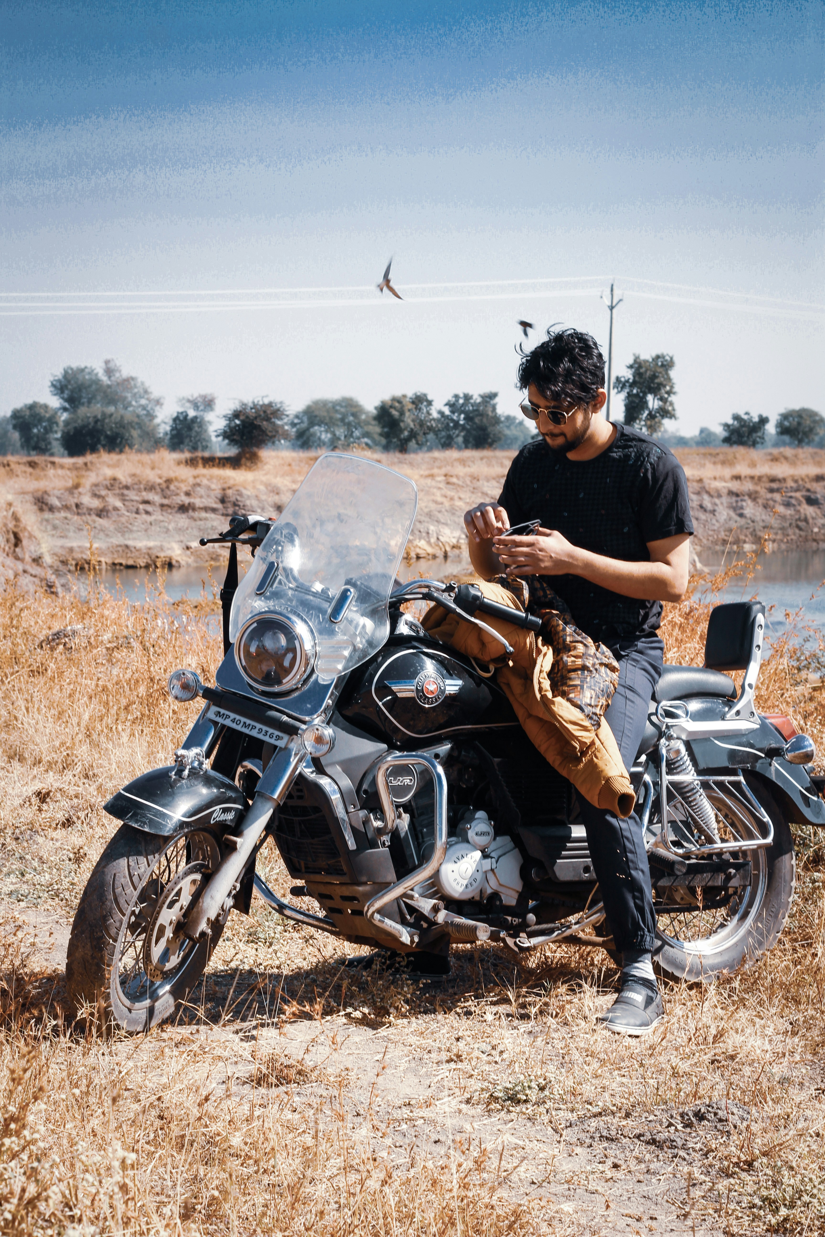 Rider in the Dust: A Sunlit Moment on a Chrome Cruiser