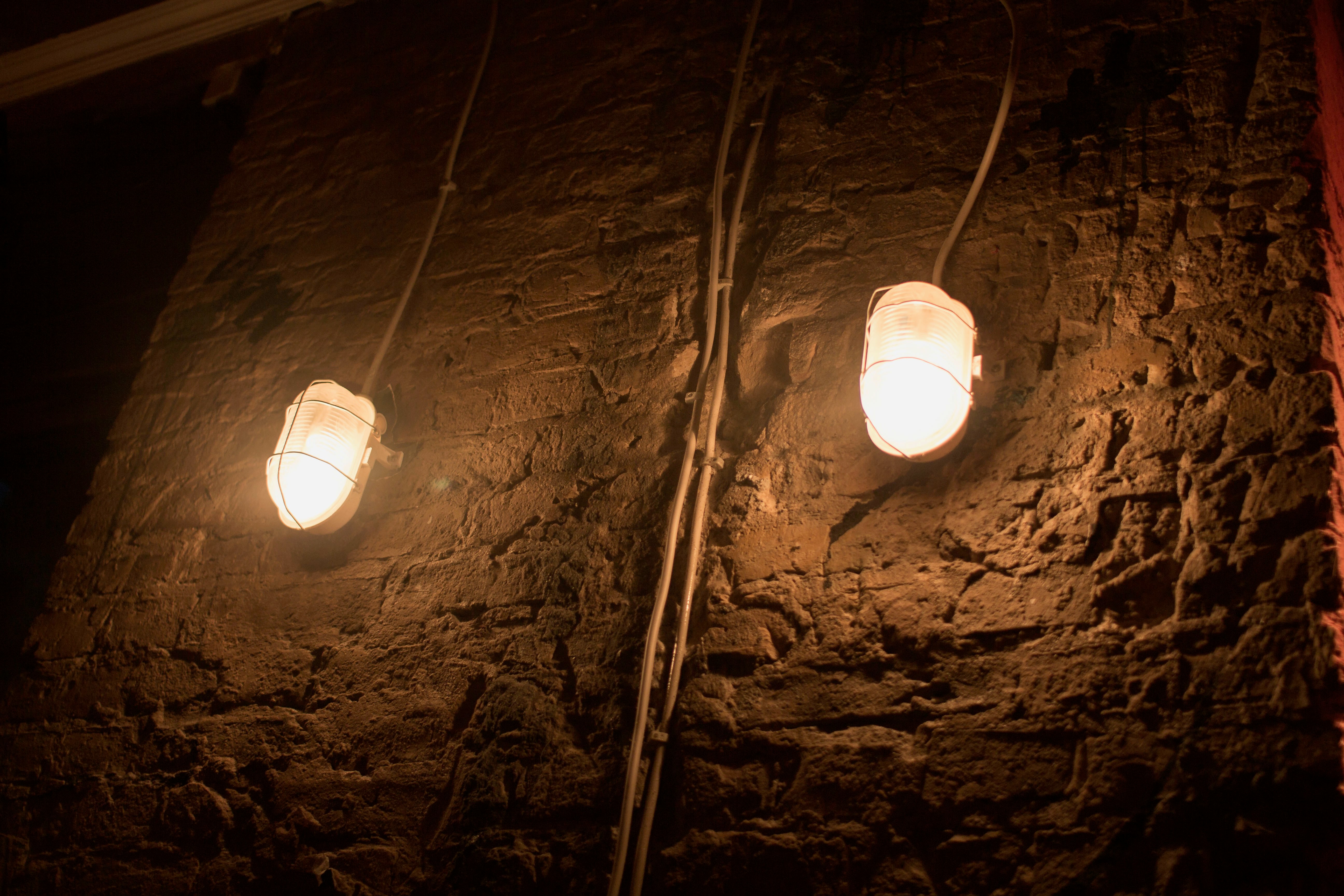 Amber Orbs Against a Weathered Brick Wall