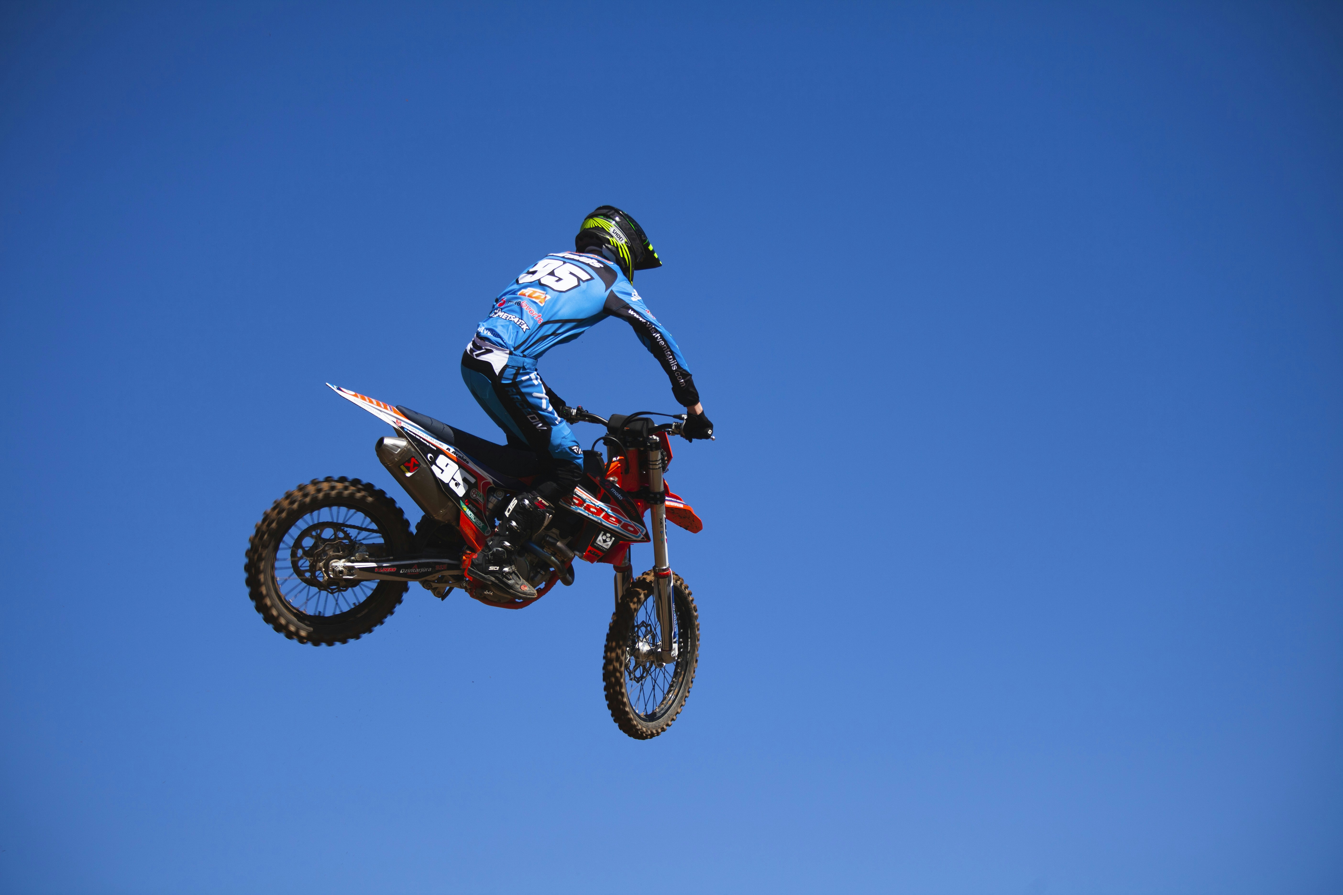 A man riding a motorcycle photo – Free Blue Image on Unsplash