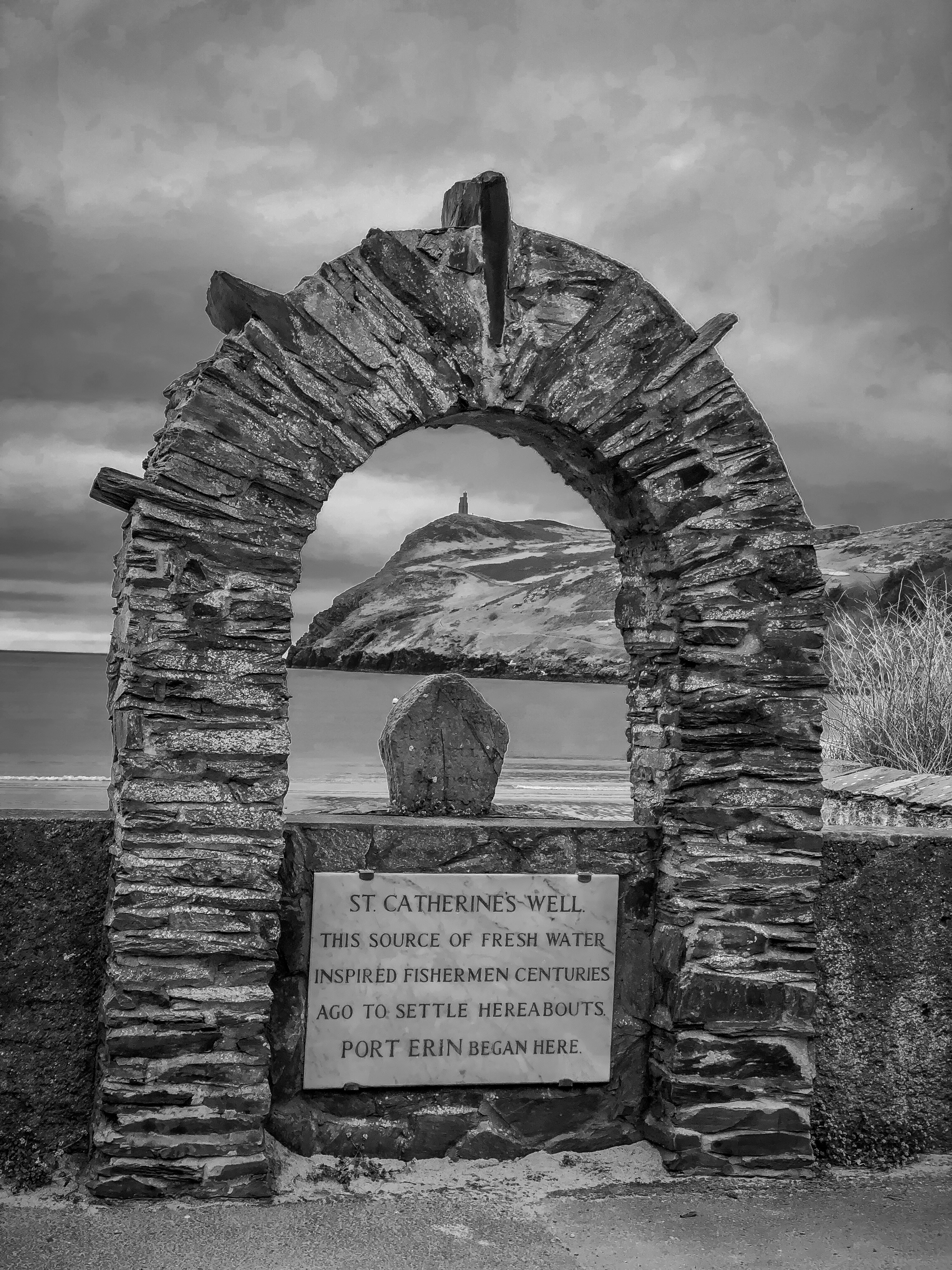 a stone archway with a sign