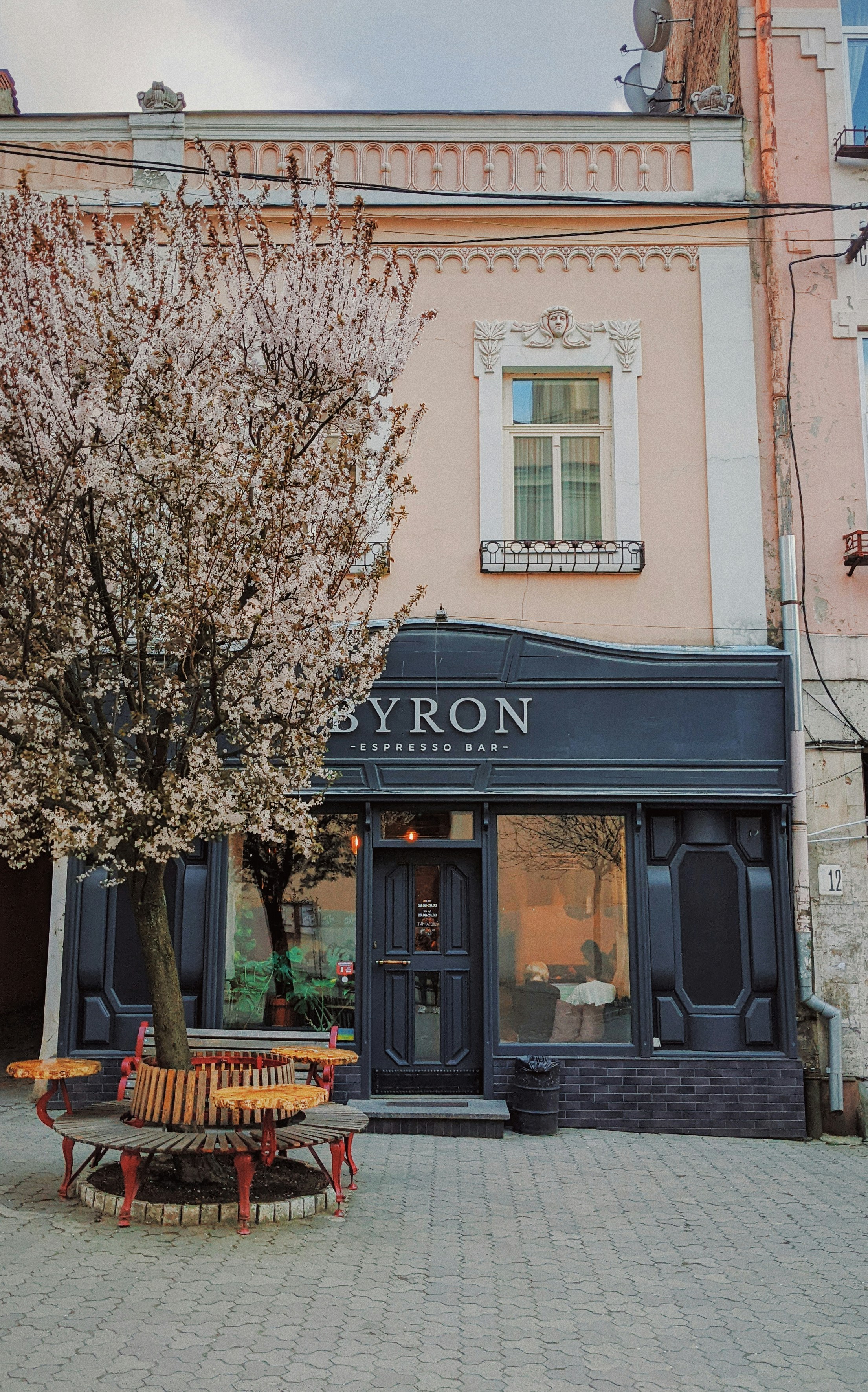 Blossoms and Bricks: Byron Espresso Bar on a Peachy Streetfront