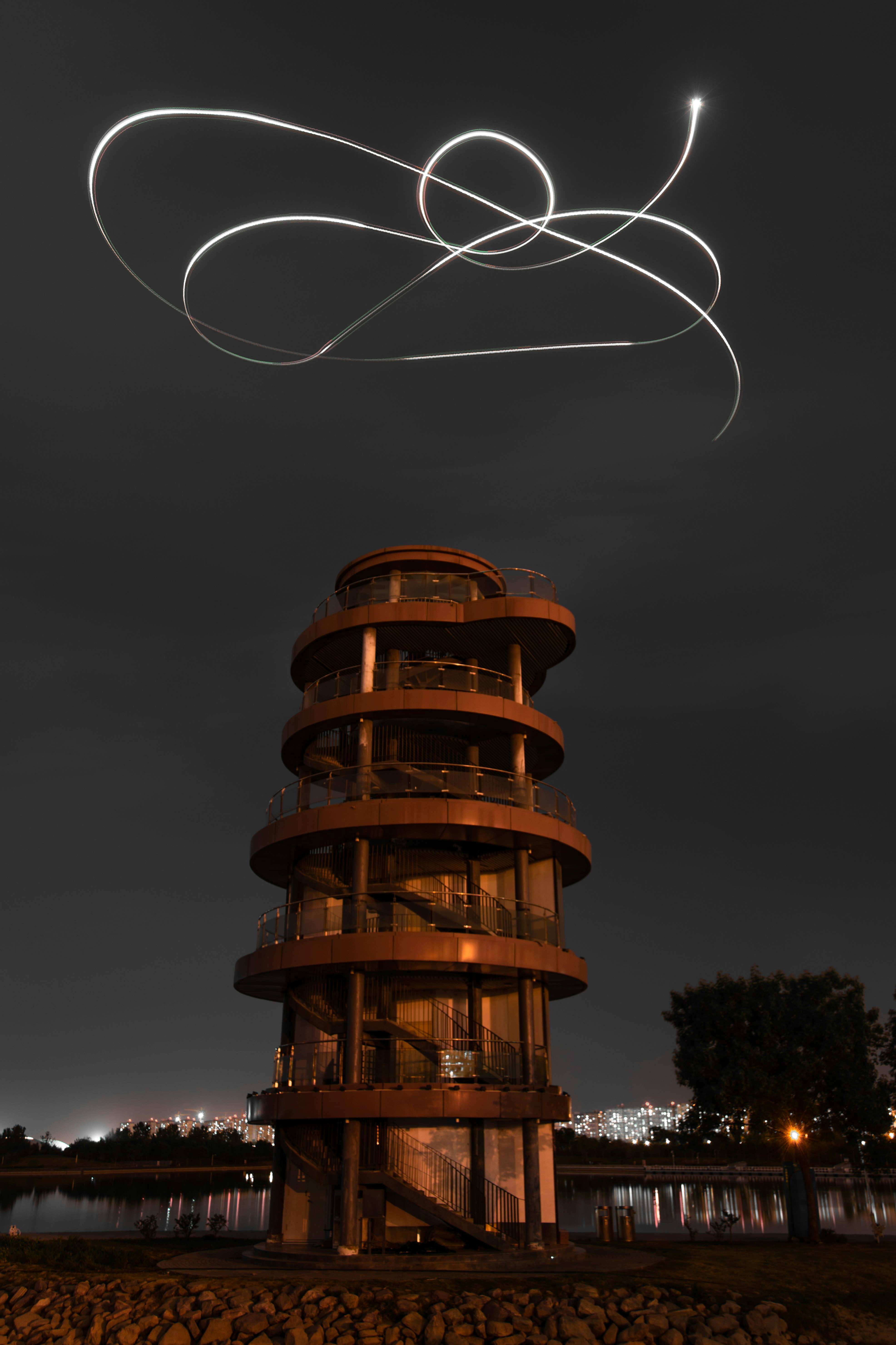 A tall tower with a light at night photo – Free Drone Image on Unsplash