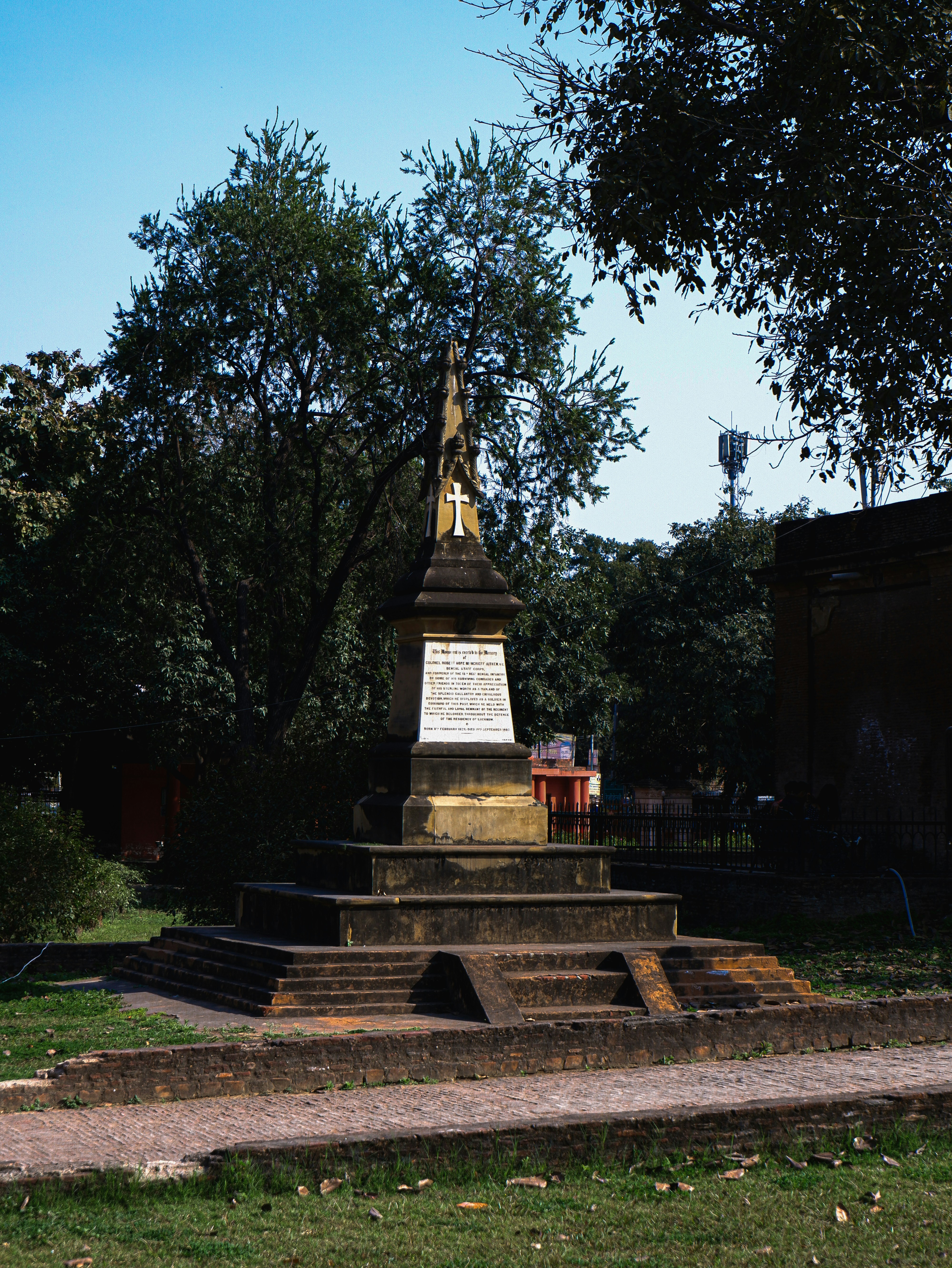 Obelisk Rising on Brick Steps: A Park Memorial Framed by Trees