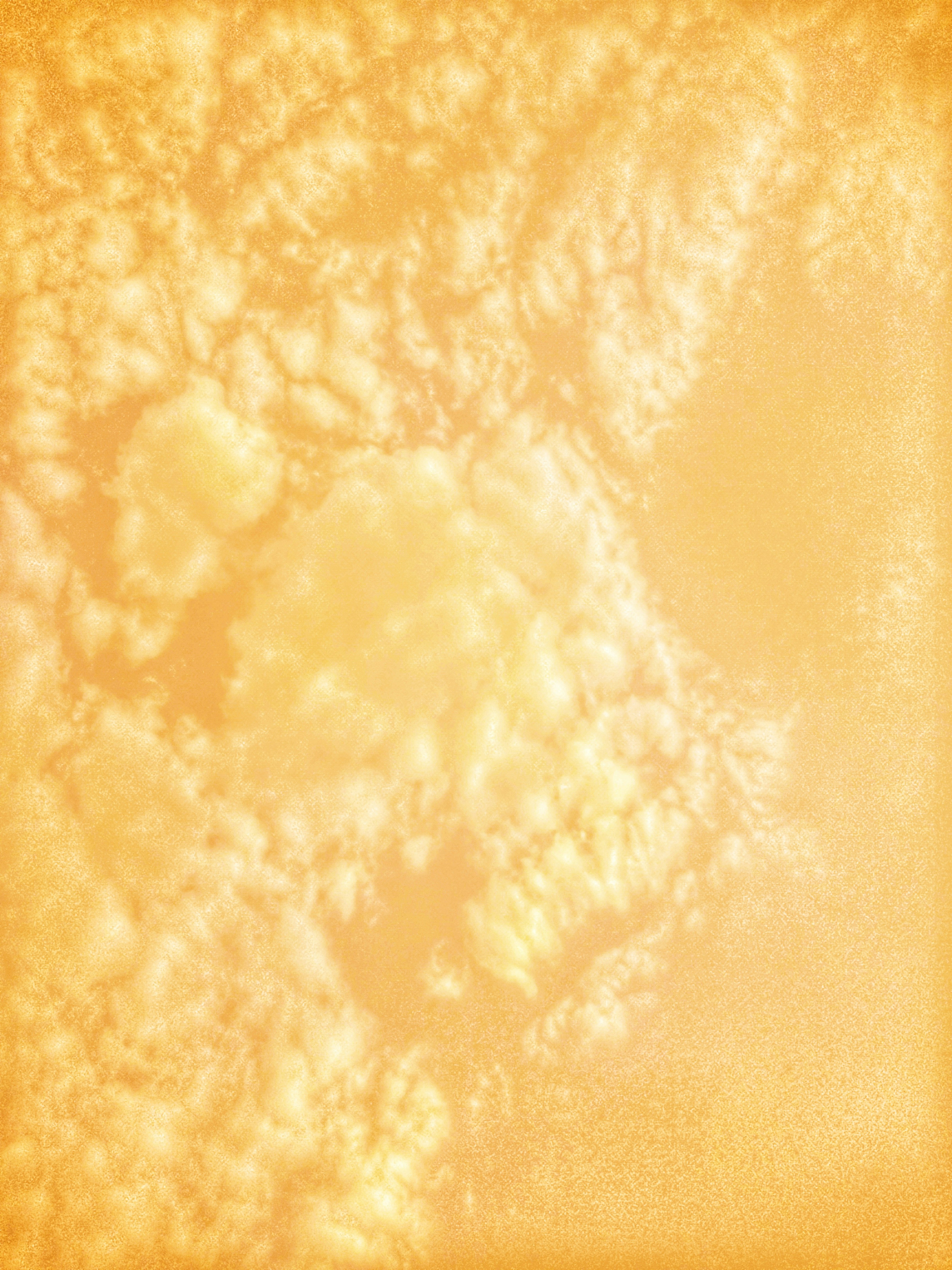 Soft, golden-hued clouds drifting across the sky, creating a dreamy atmosphere.