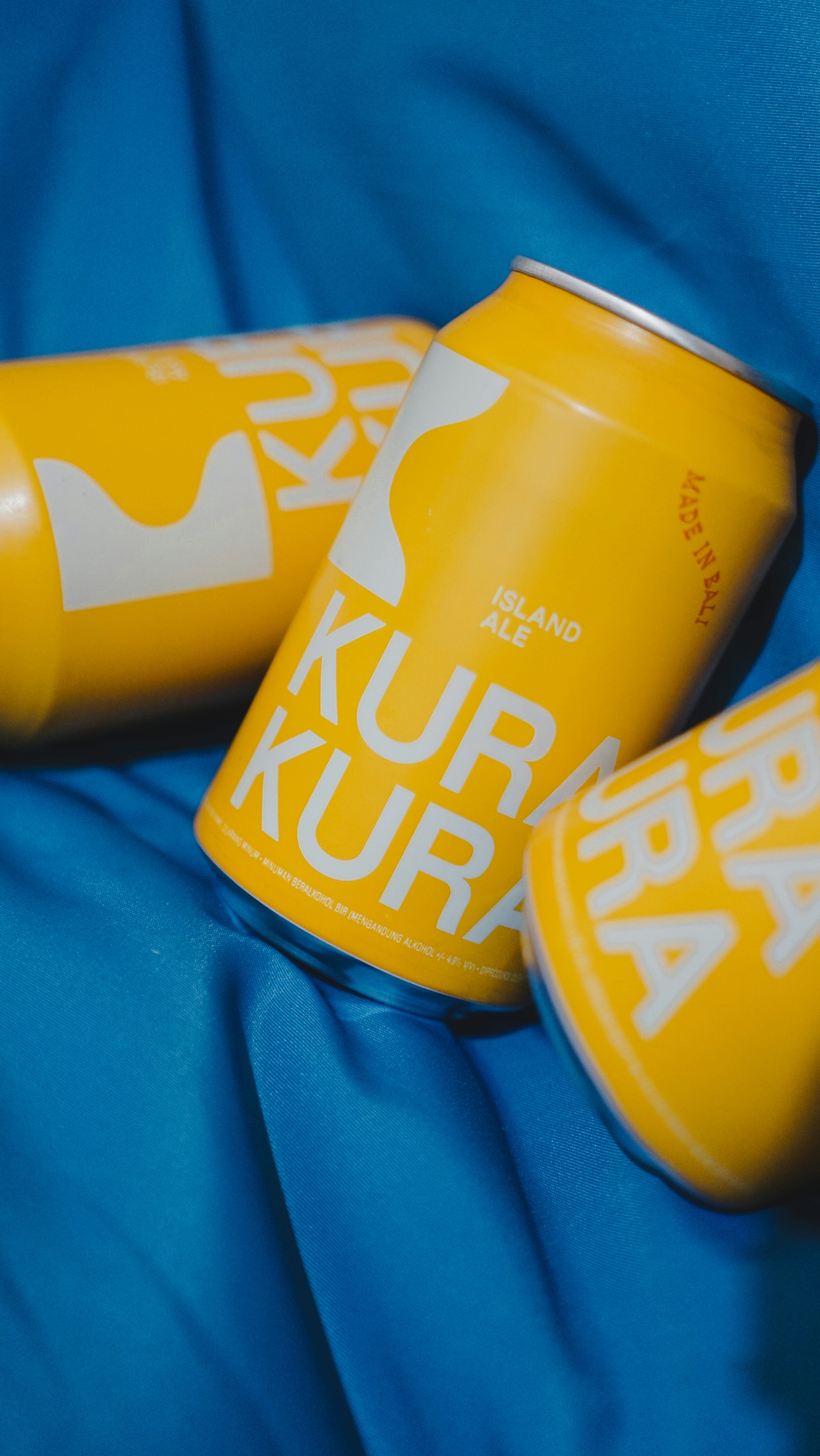 Bright Orange Kururu Cans Rest in Azure Velvet
