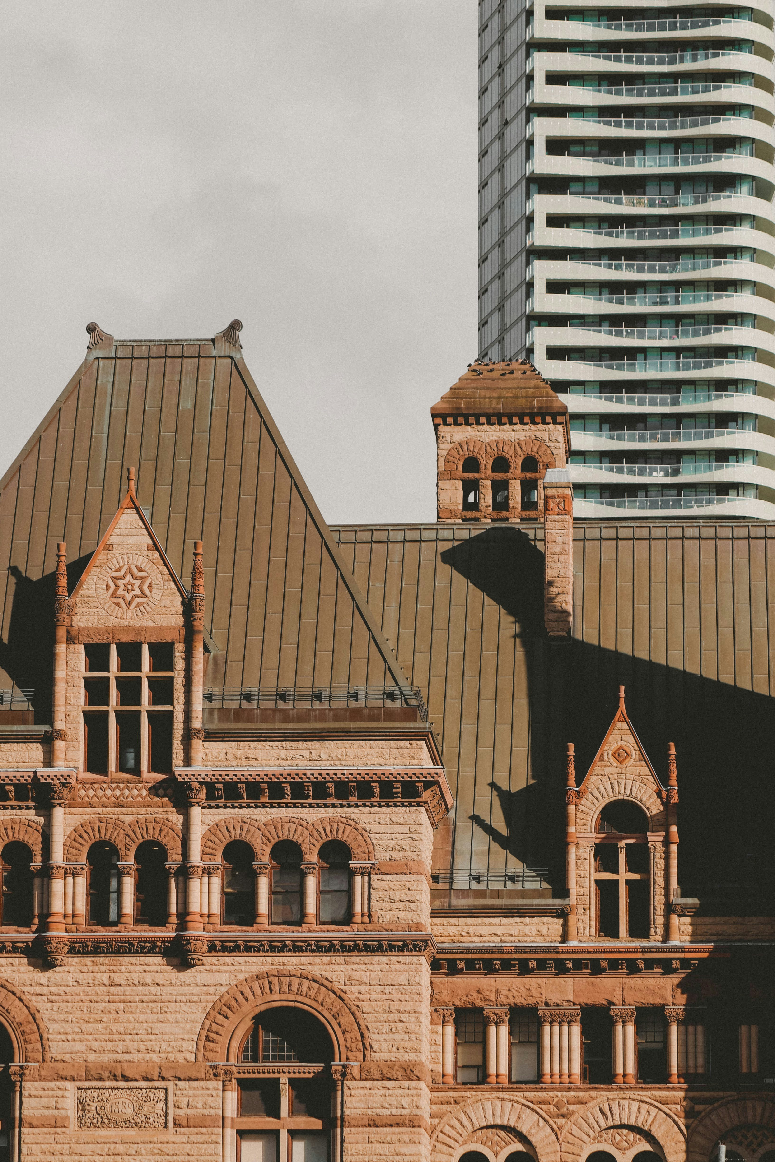 Arches Against the Glass Sky: A Heritage Facade Meets the Modern High-Rise