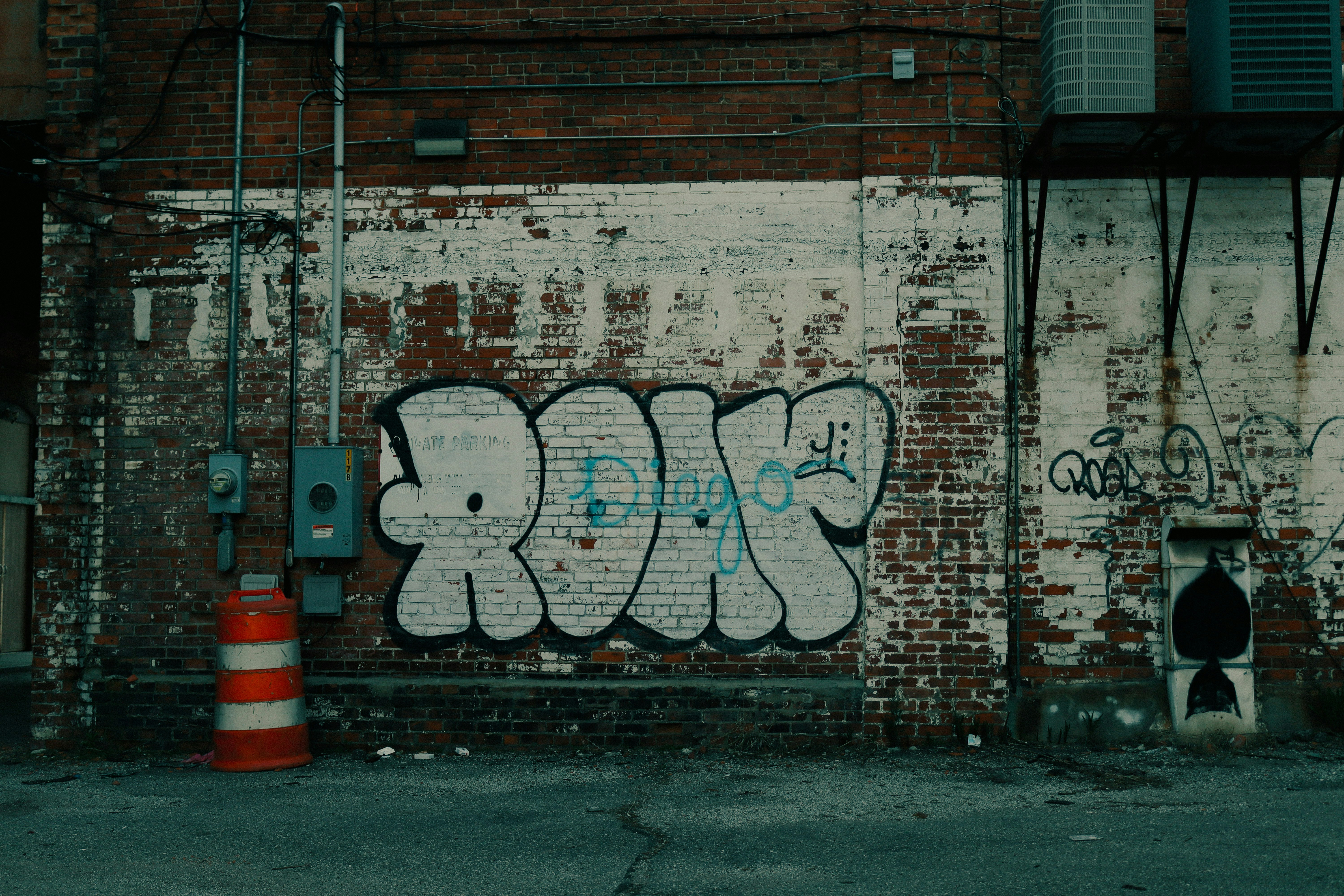 Bubble-Graffiti on a Weathered Brick Wall in an Urban Alley