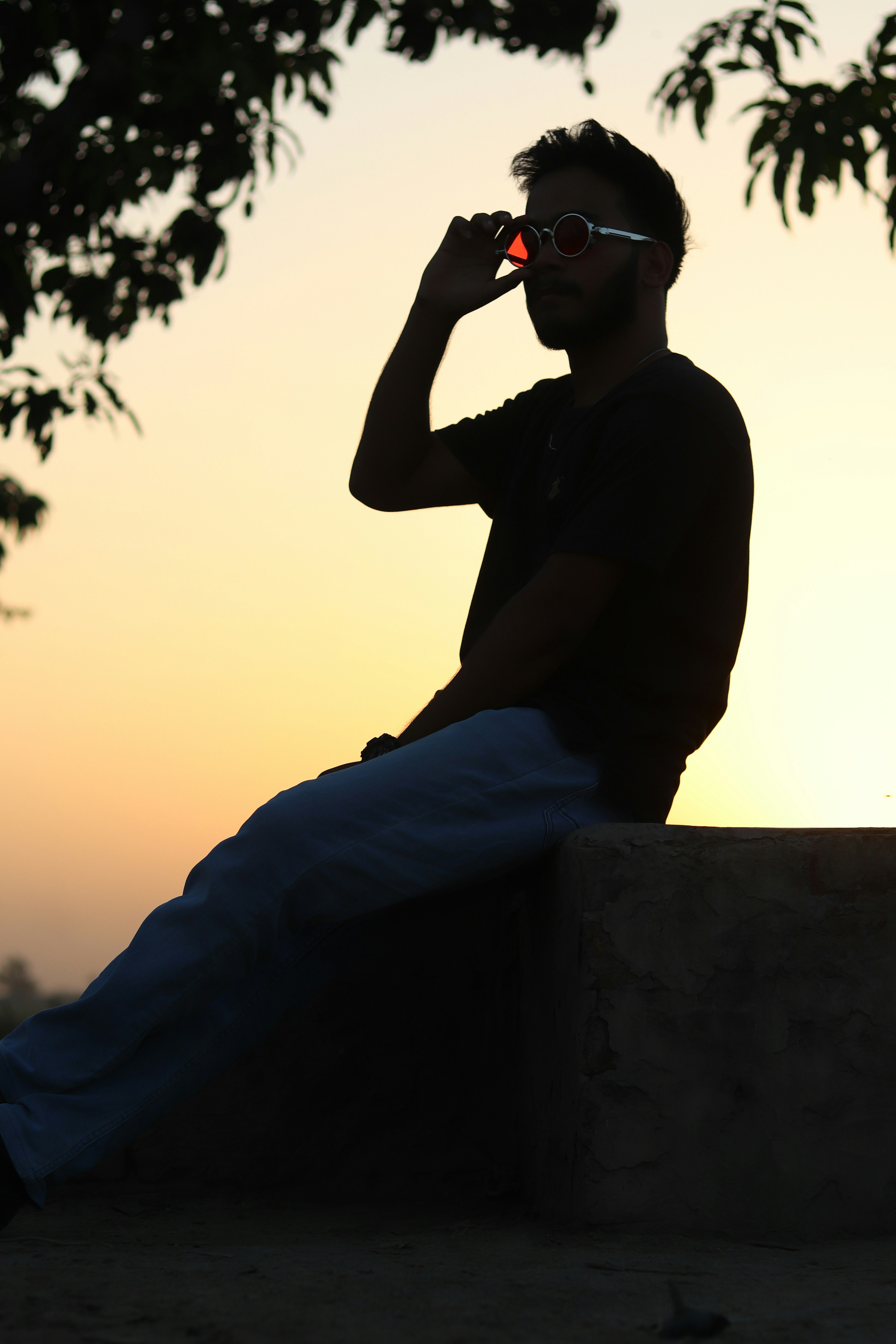 Dusk Silhouette on a Concrete Ledge: A Quiet Portrait Against the Sunset