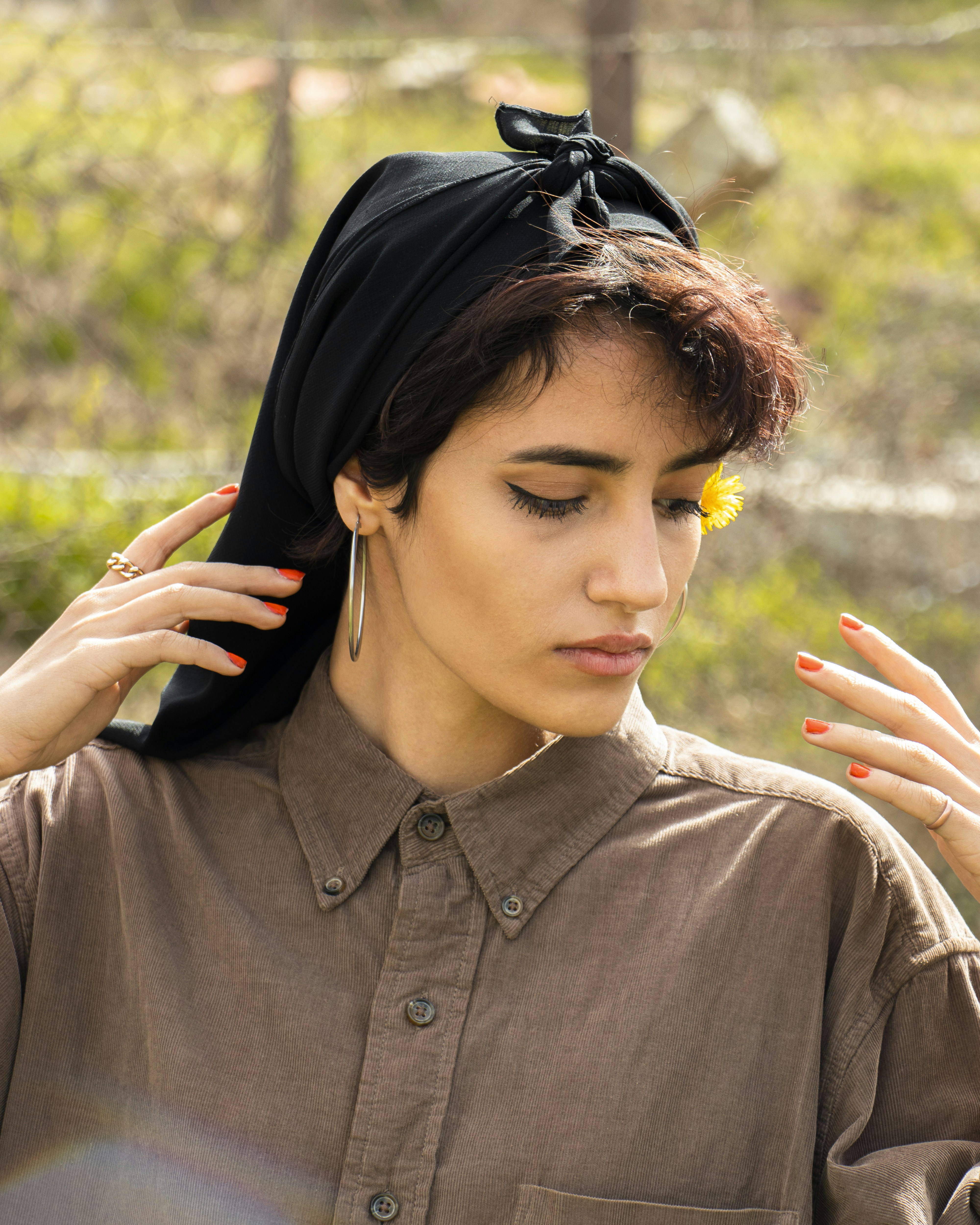 Sunlit Contemplation: A Portrait with a Yellow Bloom in Quiet Focus