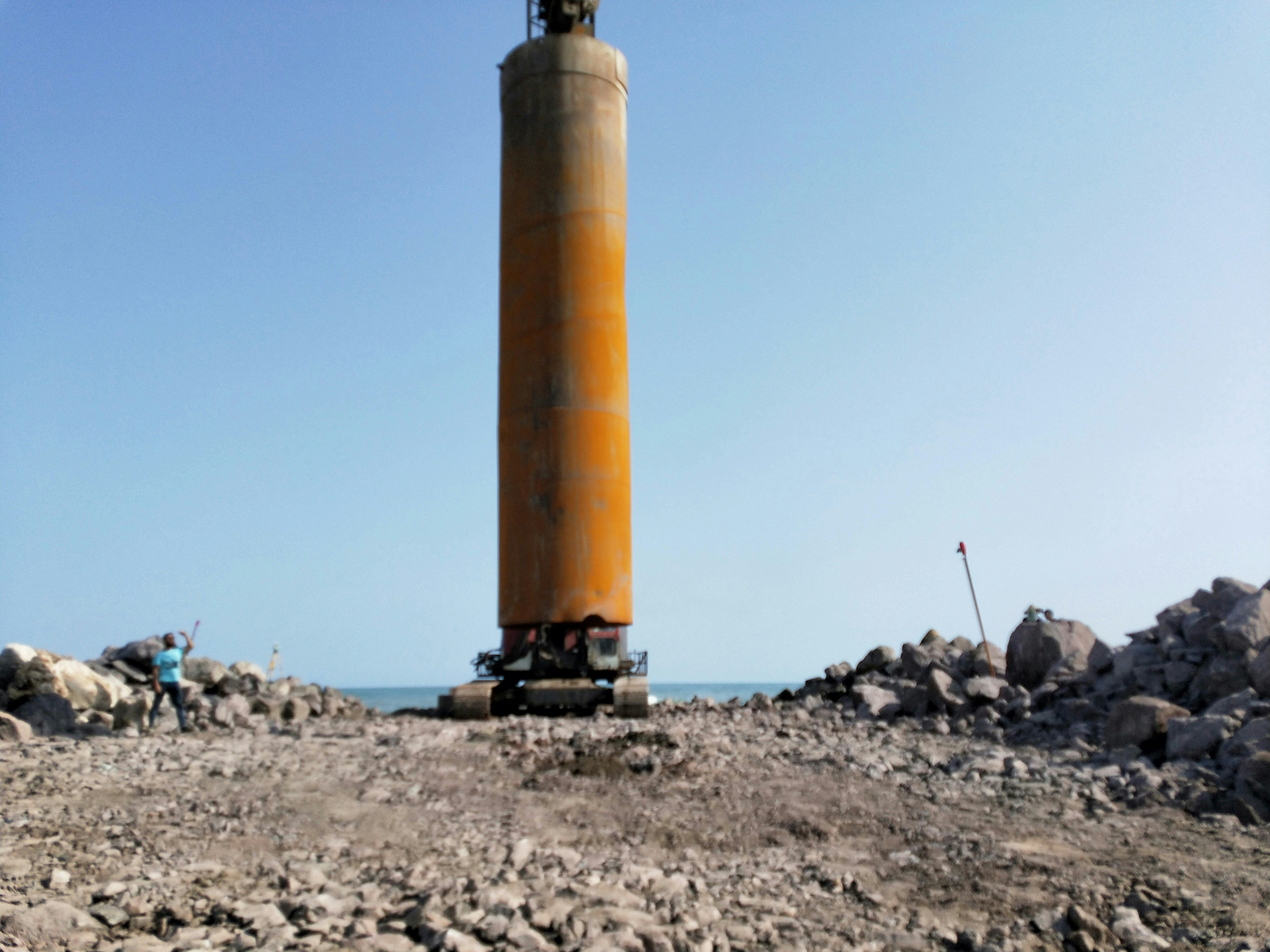 Distant Lighthouse Core: A Rusted Turret Atop a Rocky Pier