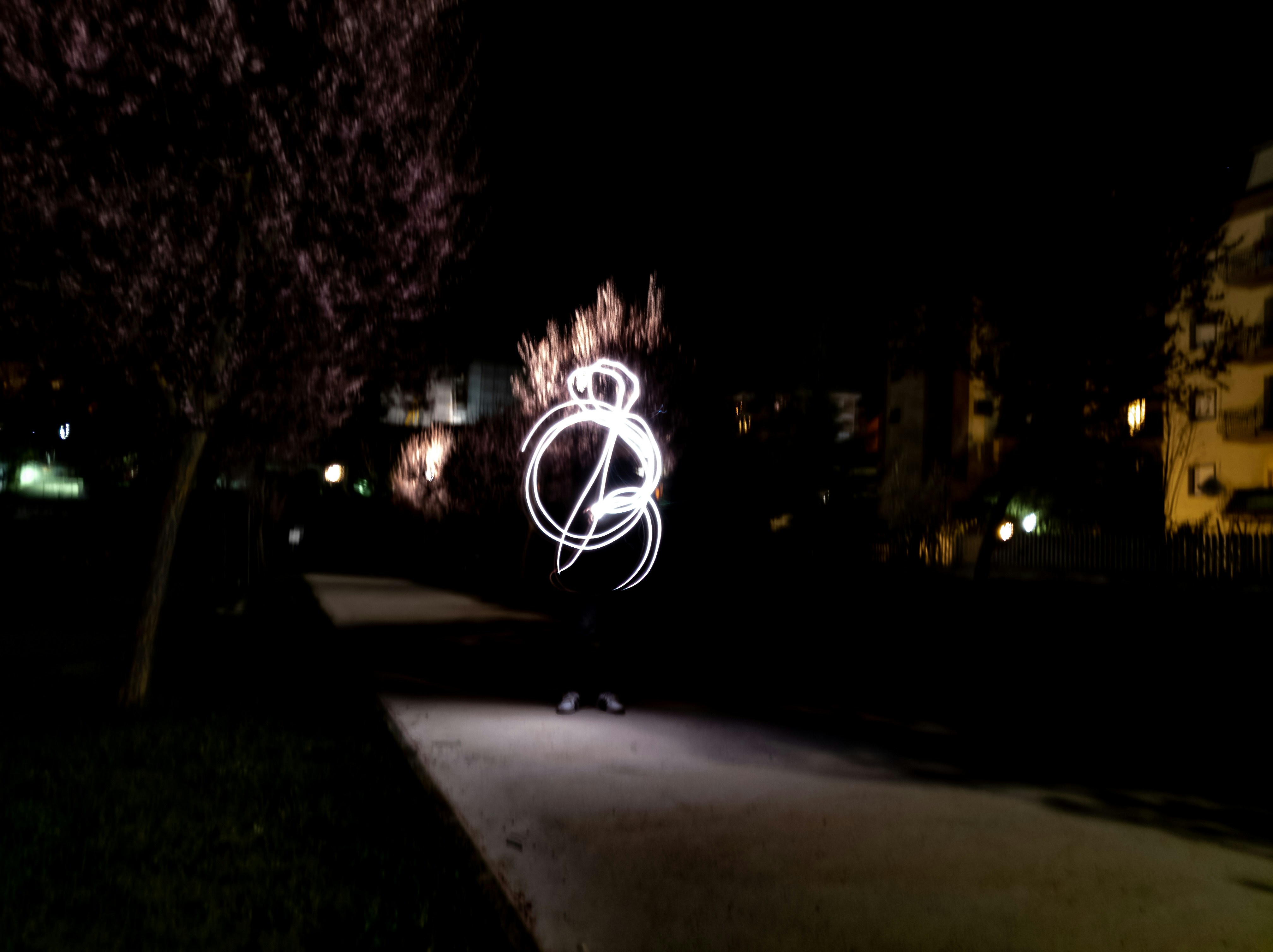 Light Portrait in Motion: a gentle glowing figure guides a quiet park path