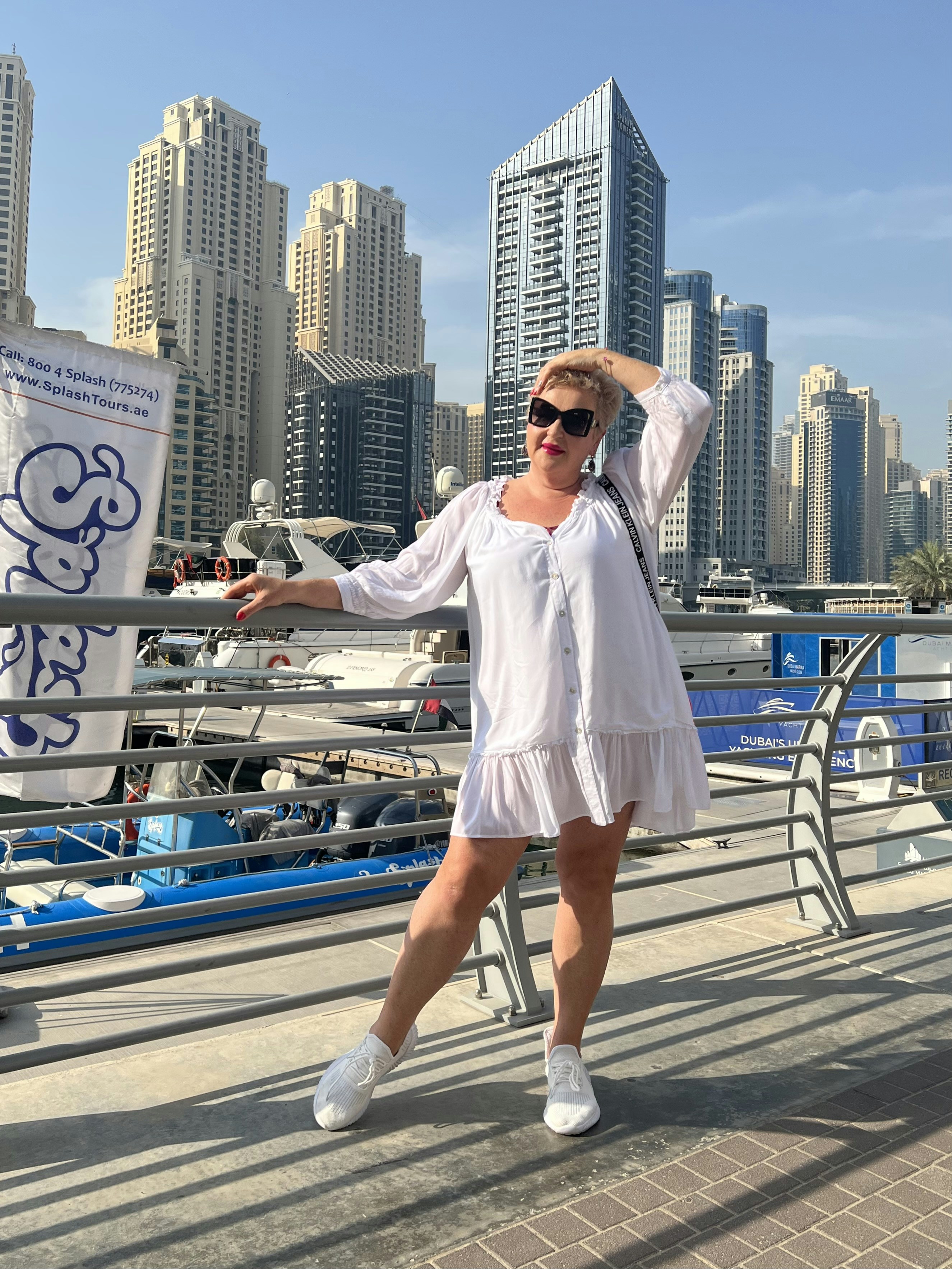 Sunny Marina Pose: White Dress and City Backdrop