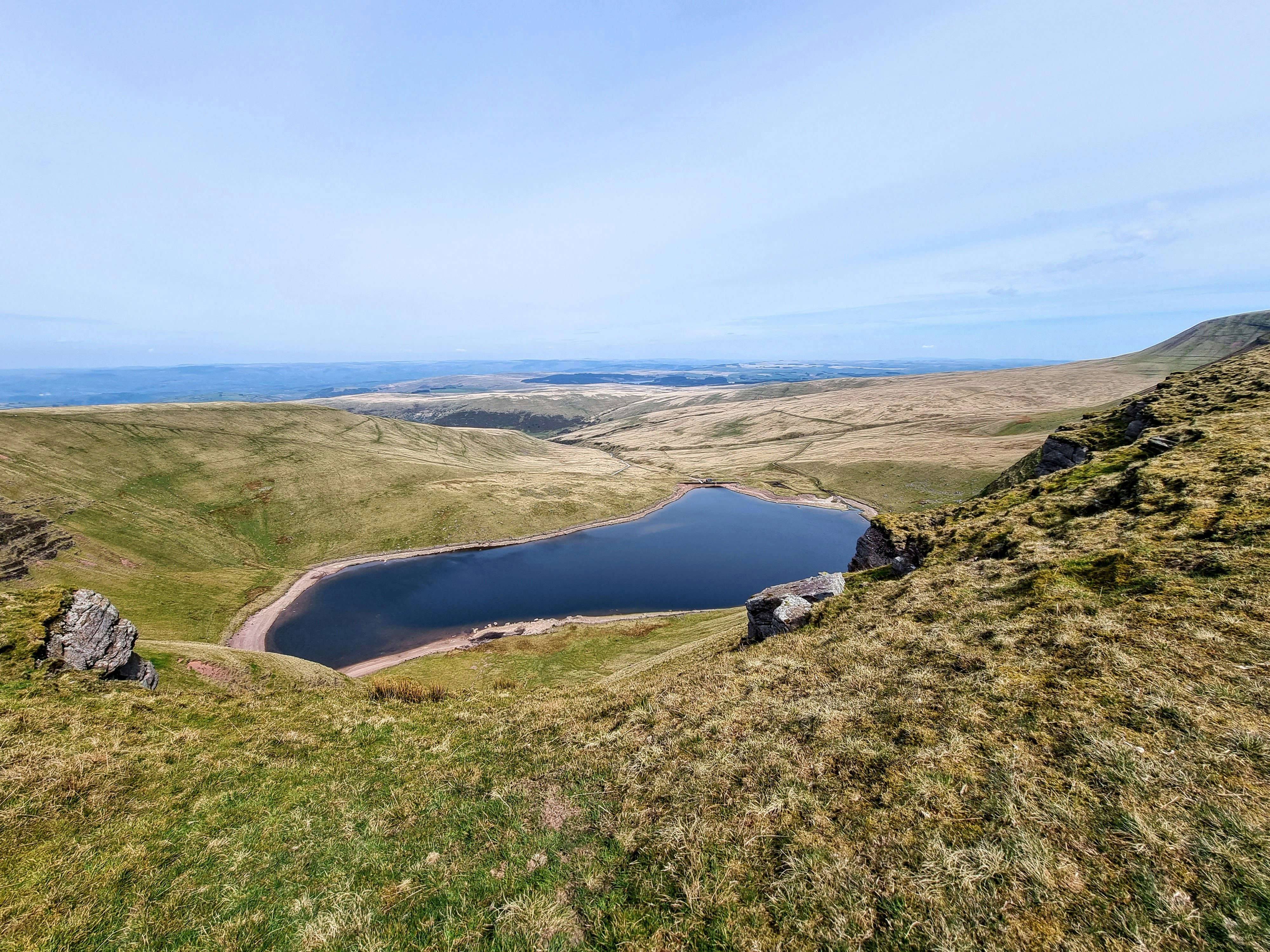 Highland Mirror: A Quiet Lake Nestled Between Rolling Hills