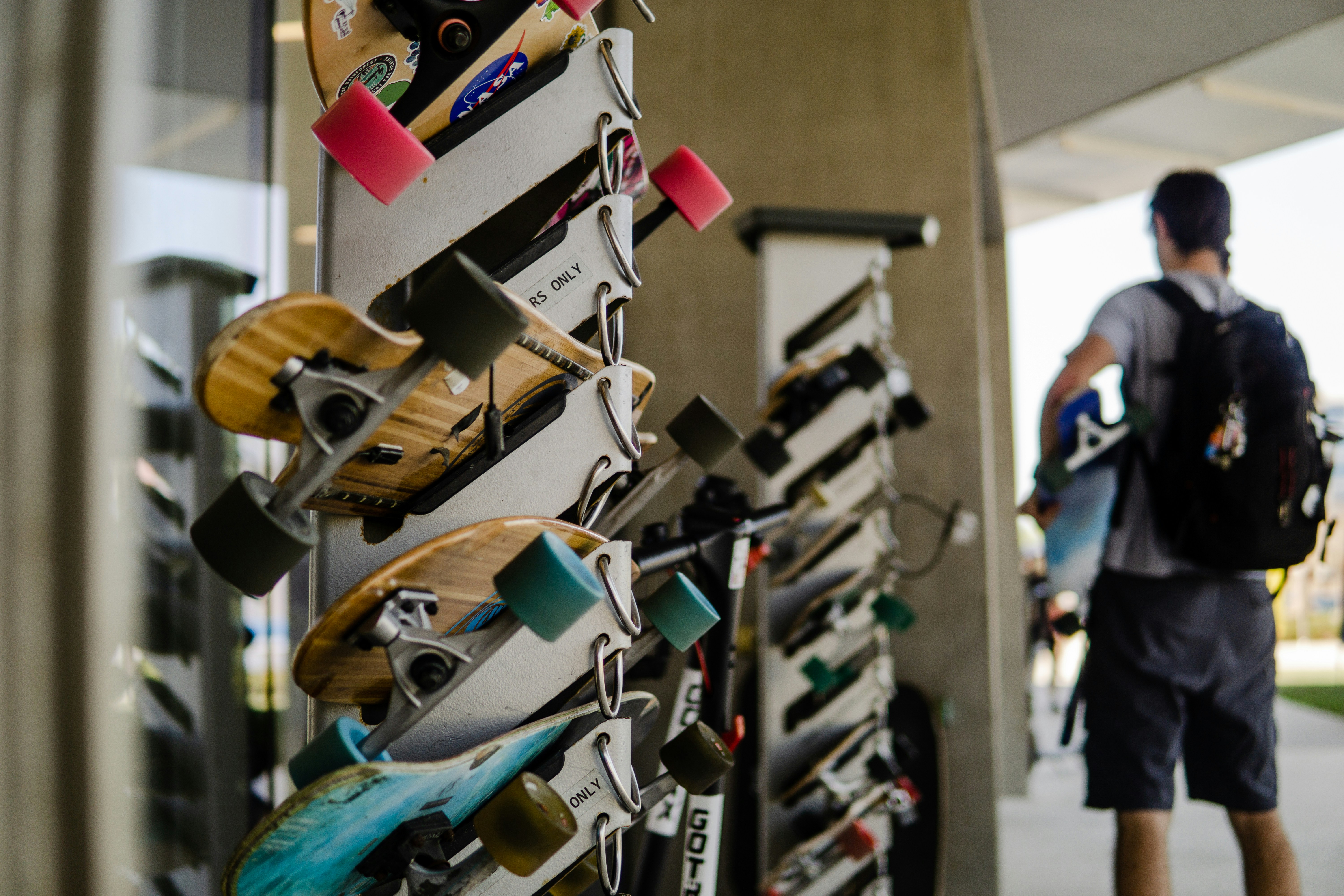 a person walking past a wall of shoes