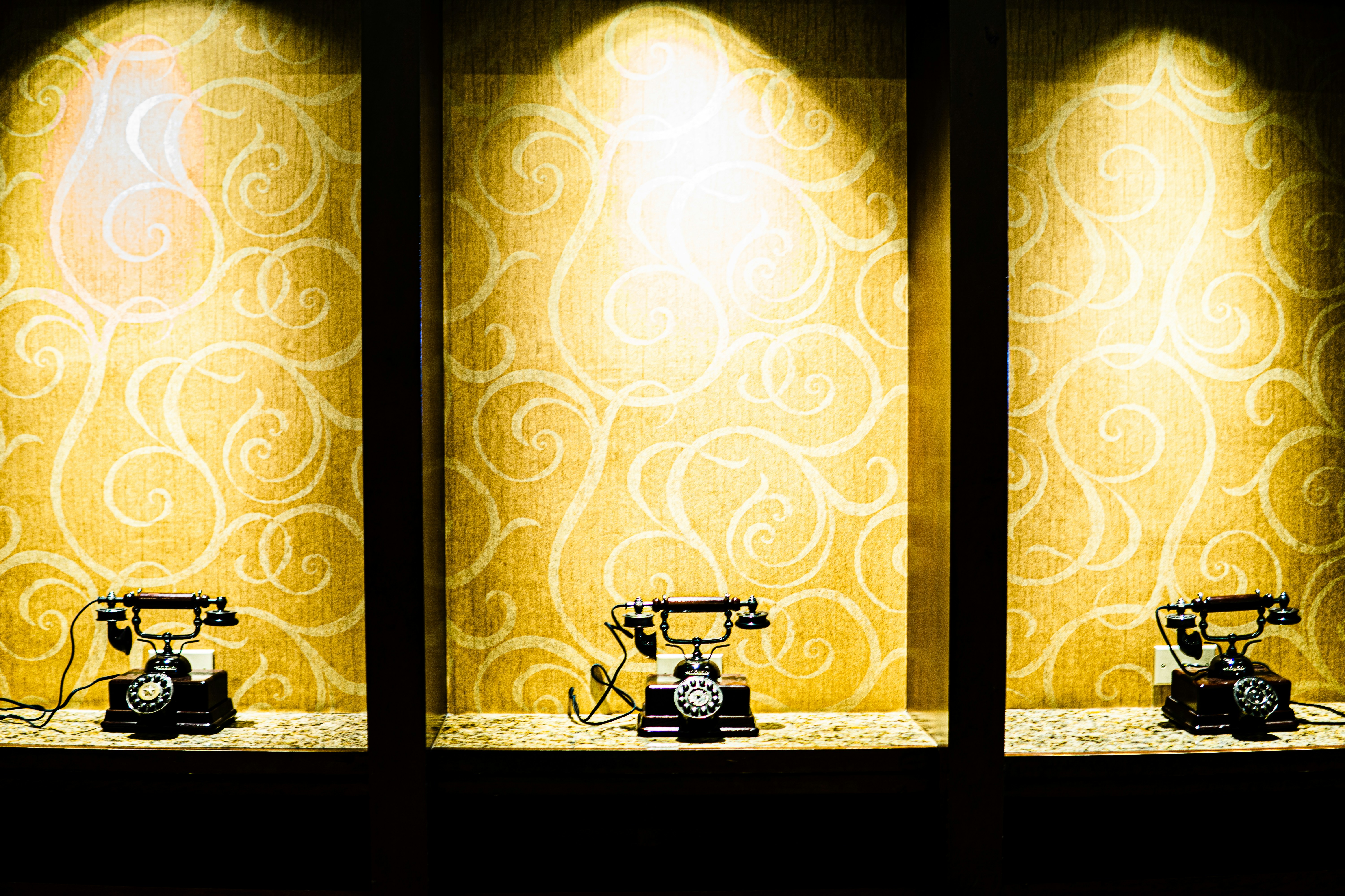 Triptych of Vintage Telephones in Amber Light