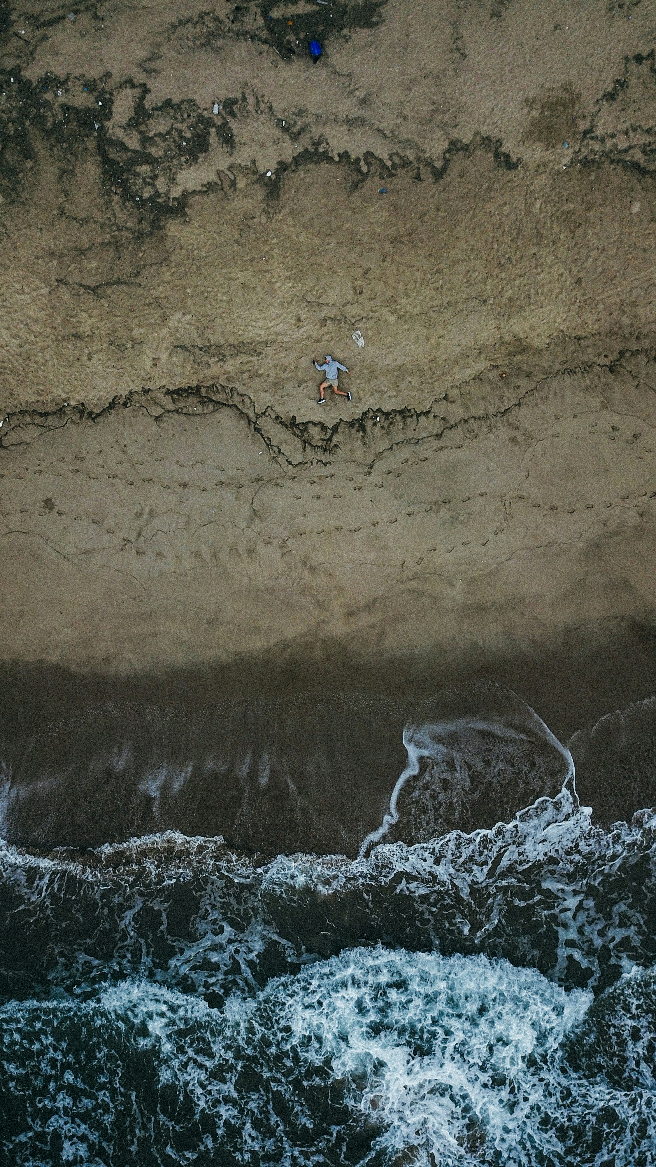Dune Beach Dwellers: A Lone Silhouette Among Tidal Lines