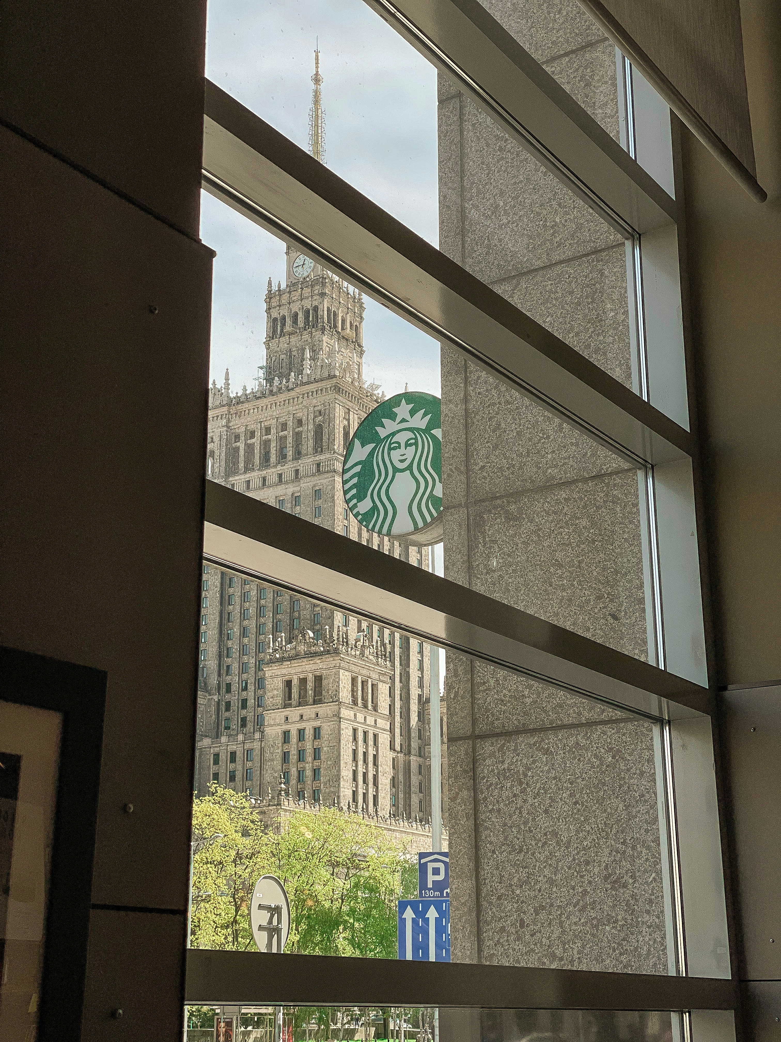 Through the Window: Starbucks Logo Framed by City Architecture