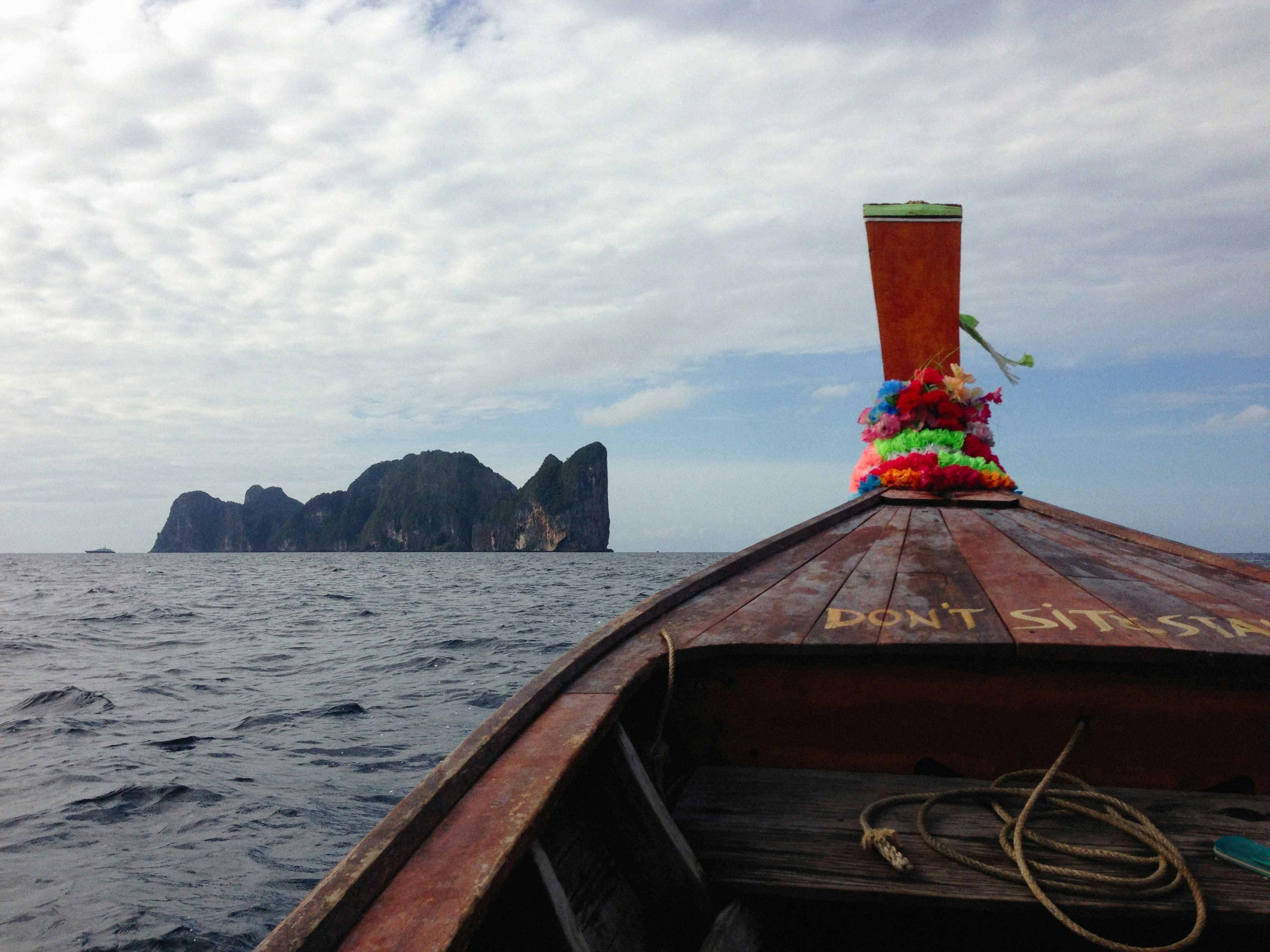 Bow of a Traditional Longtail Boat Pointing Toward Distant Limestone Islets