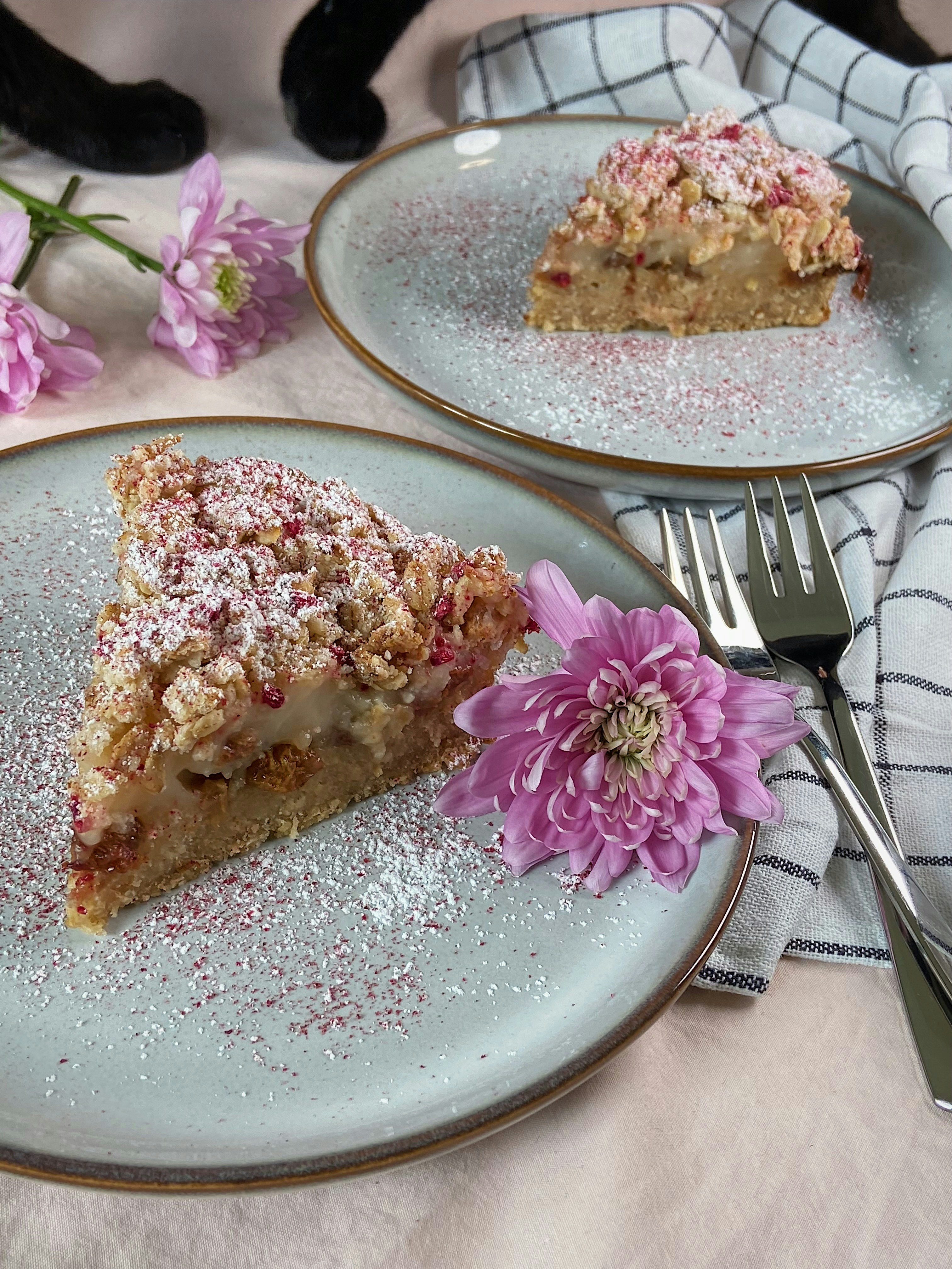 Two Tart Slices with Purple Chrysanthemums on a Rustic Table
