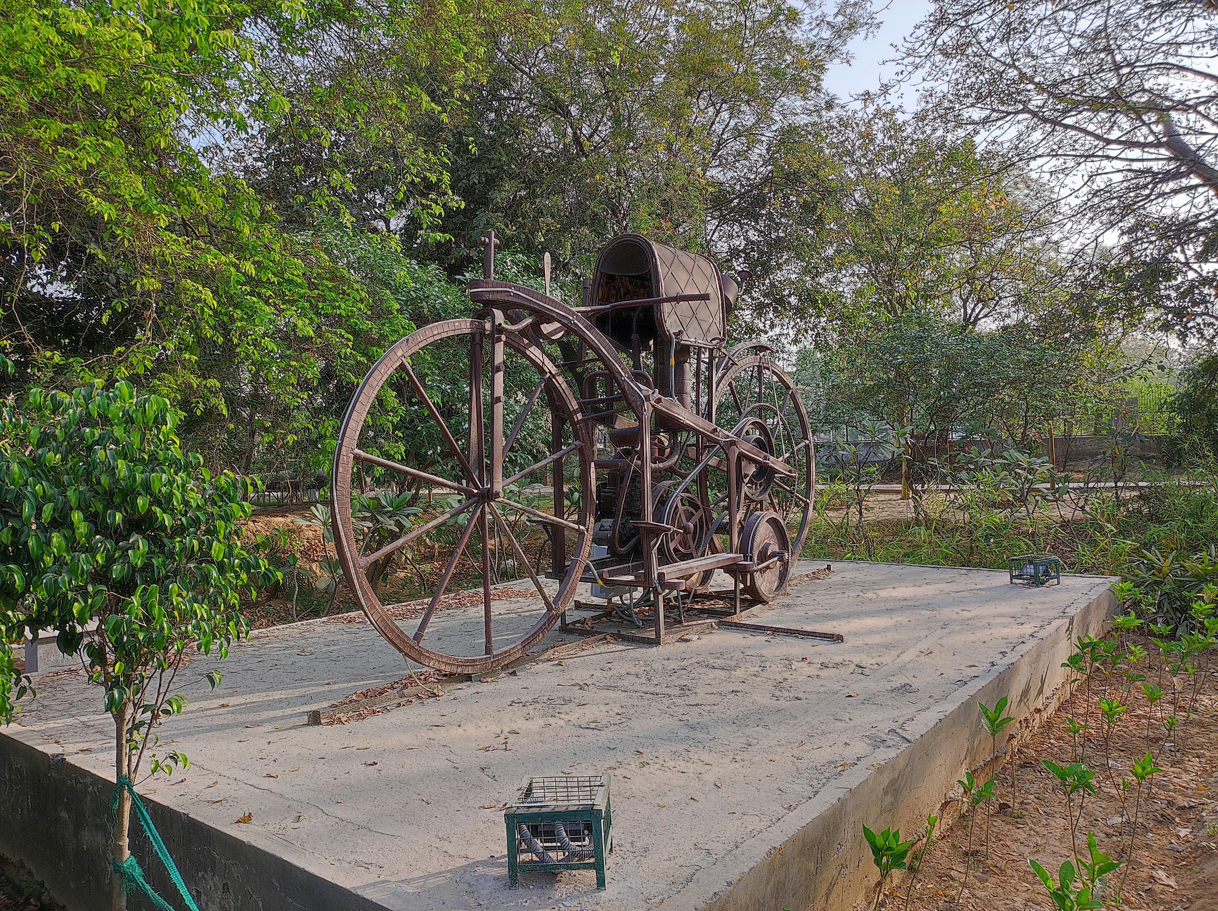 Rust-Covered Pedal-Driven Relic in a Garden Clearing
